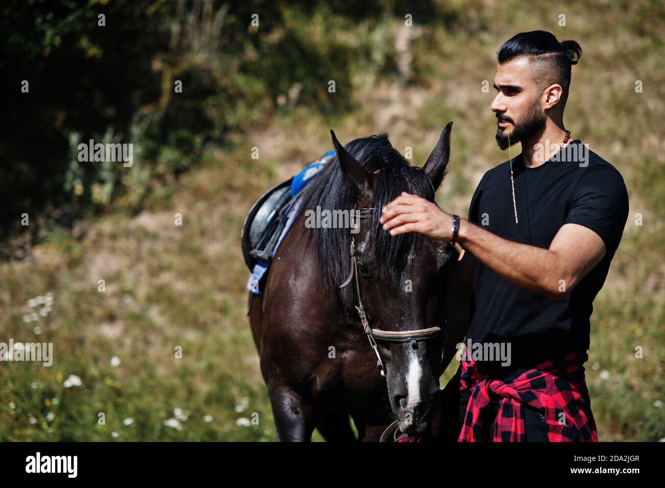 Arab tall beard man wear in black with arabian horse Stock Photo - Alamy