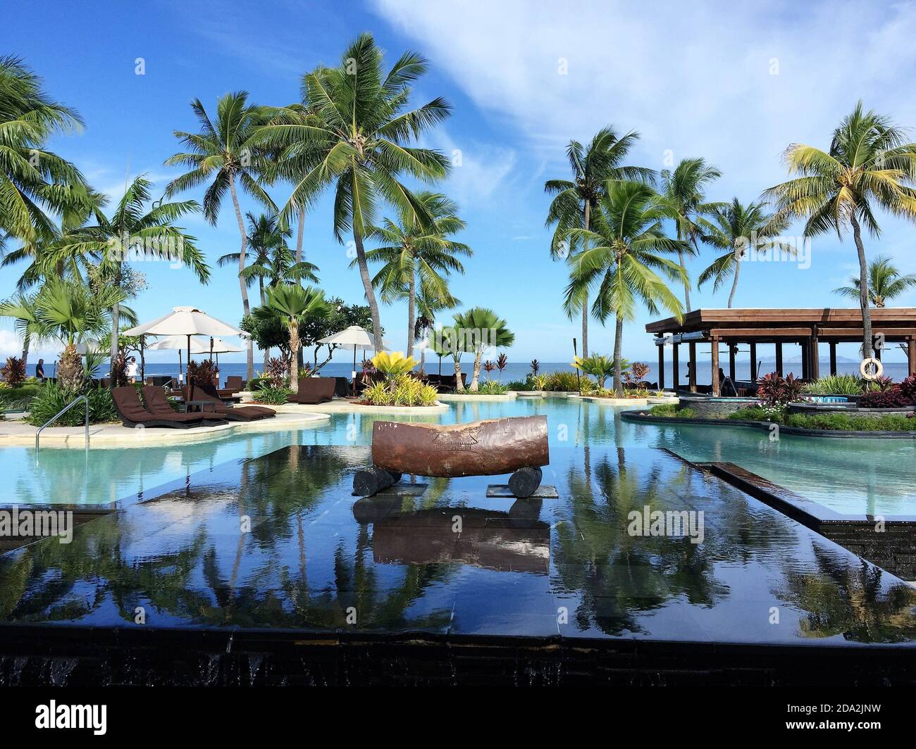 Luxury resort in Fiji with a water feature with palm trees and a ...