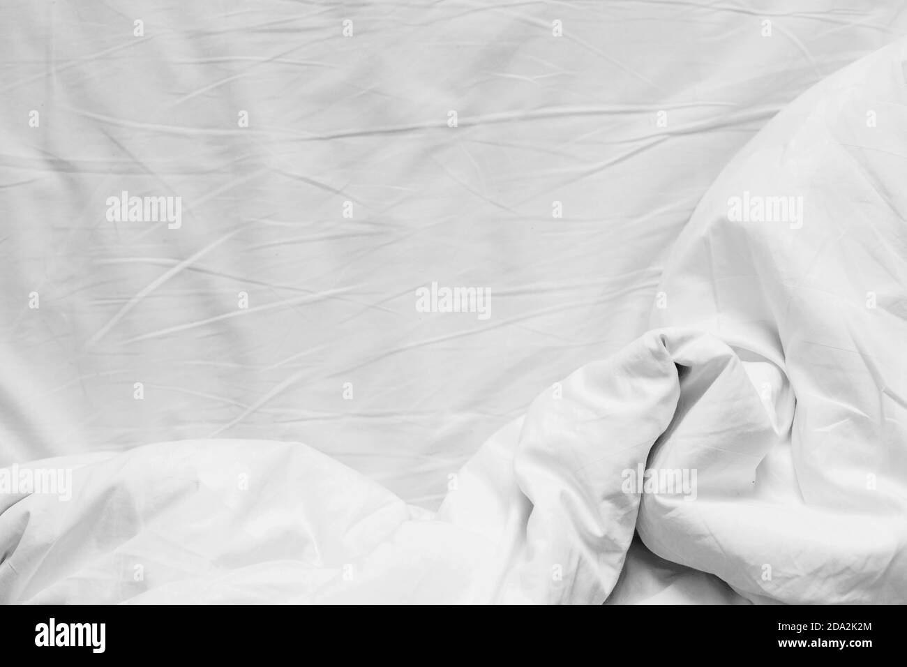 Top view of white cotton crumpled sheet and crumpled blanket with copy ...