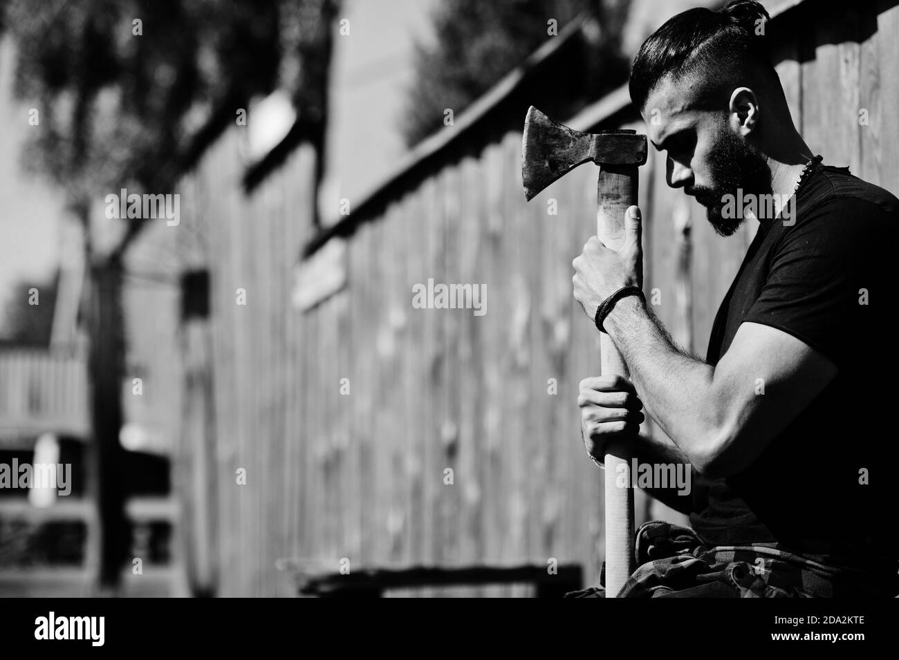Portrait handsome bearded man holding Black and White Stock Photos ...