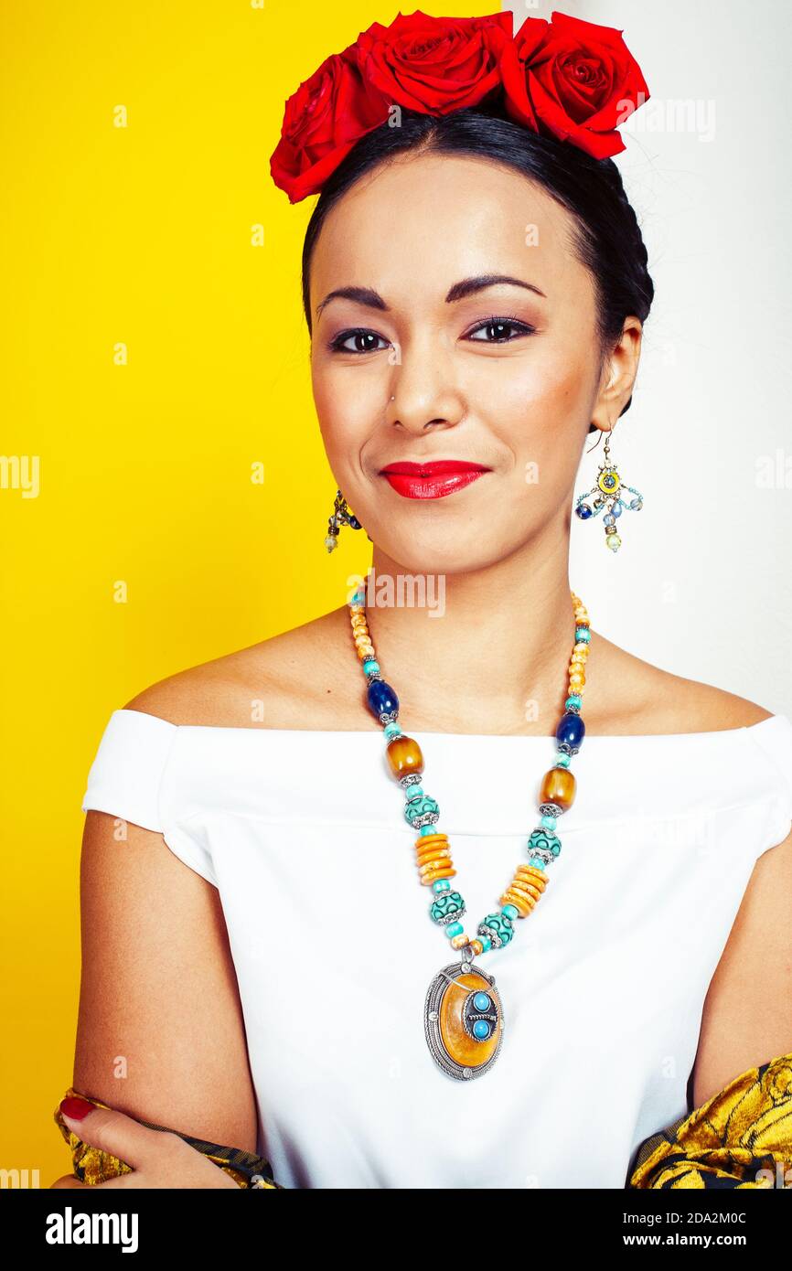 young pretty mexican woman smiling happy on yellow background ...