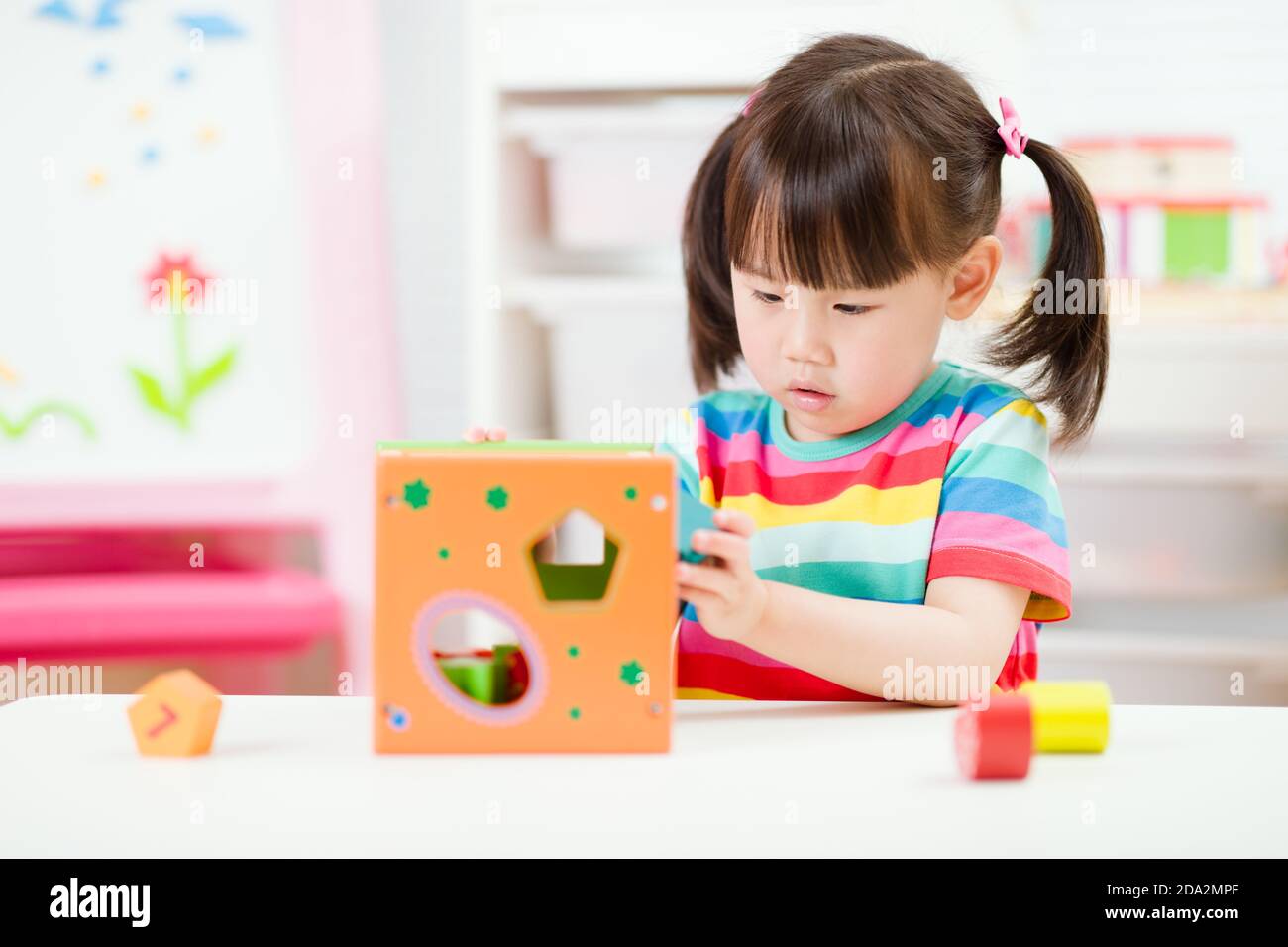young girl playing number shape blocks for homeschooling Stock Photo ...