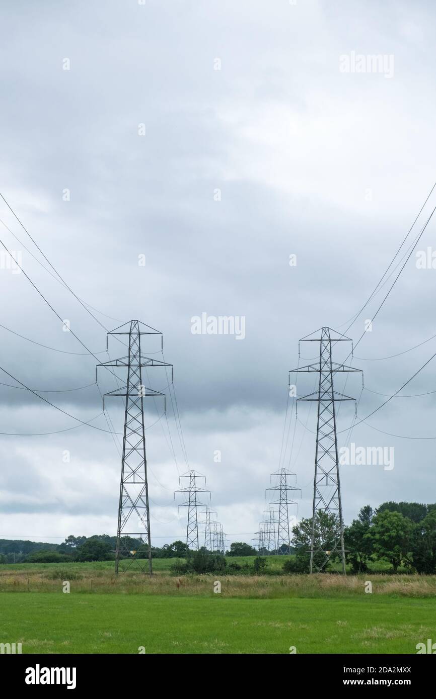 Electricity pylons ranged across the English countryside in East Devon ...