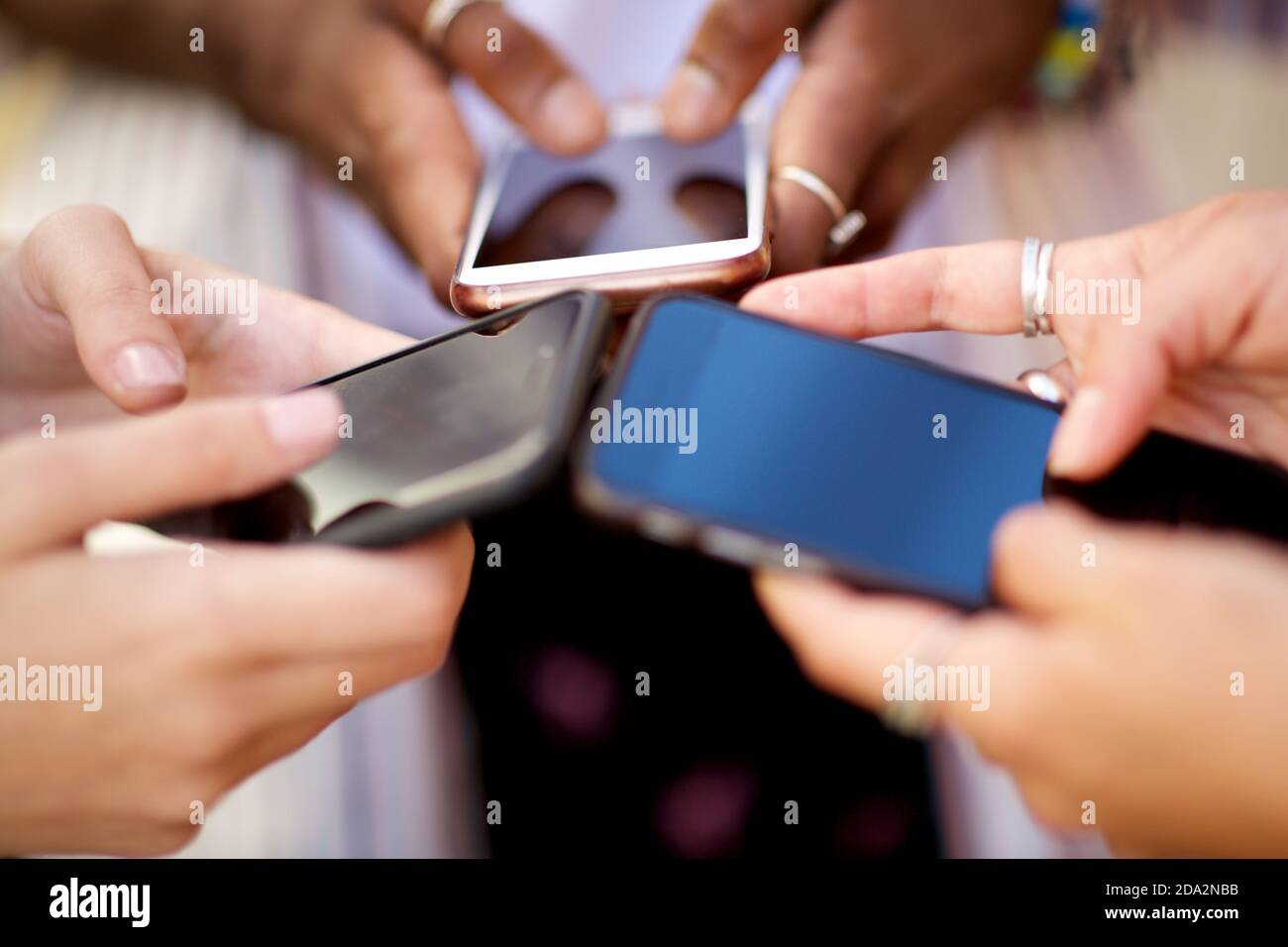 Close up group of young women hands holding mobile phones Stock Photo ...