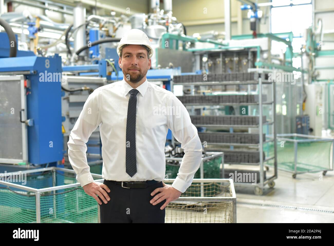 portrait of a successful smiling businessman/ engineer on site in an ...