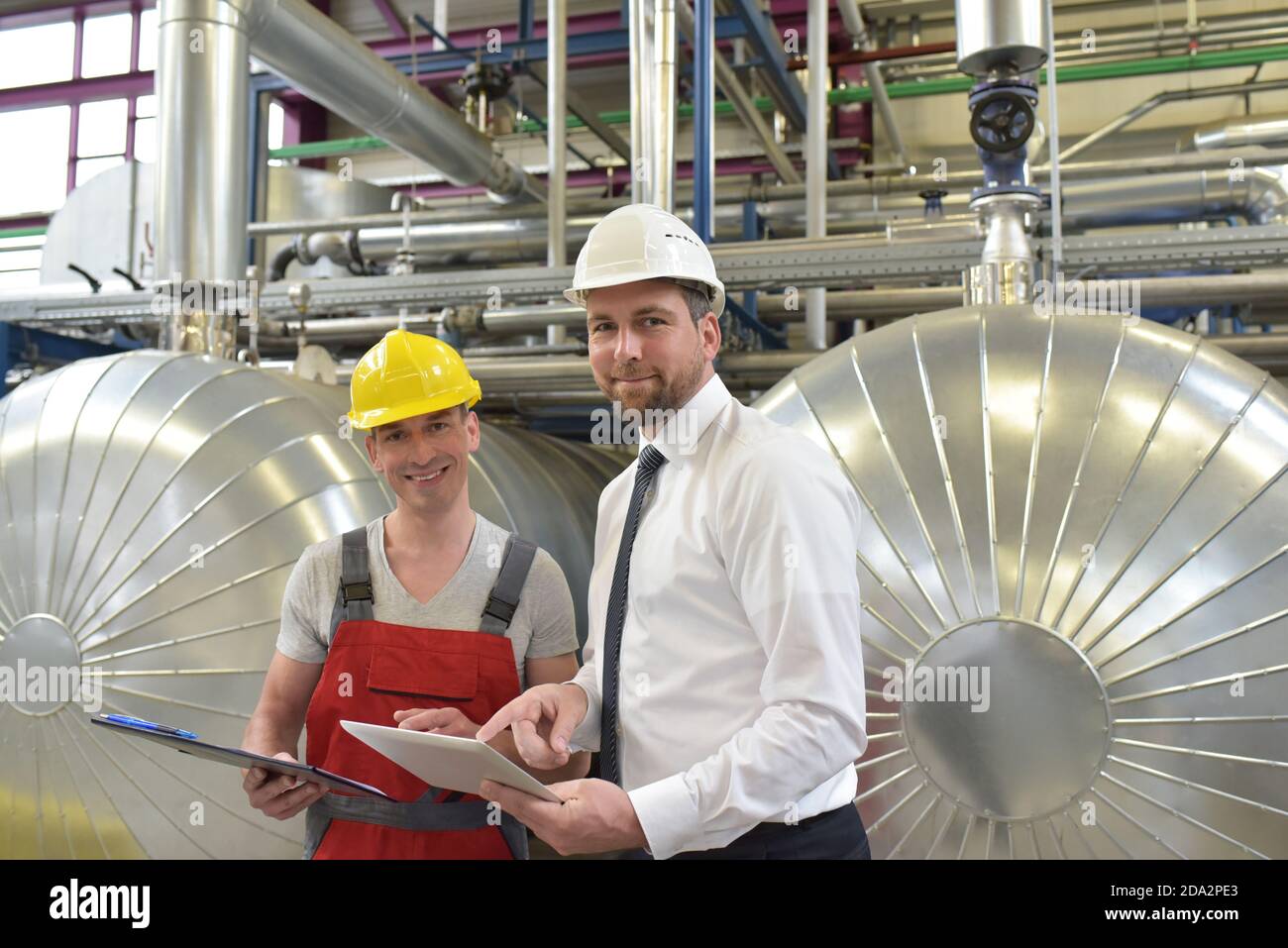 businessman and worker meeting in a factory - maintenance and repair of ...