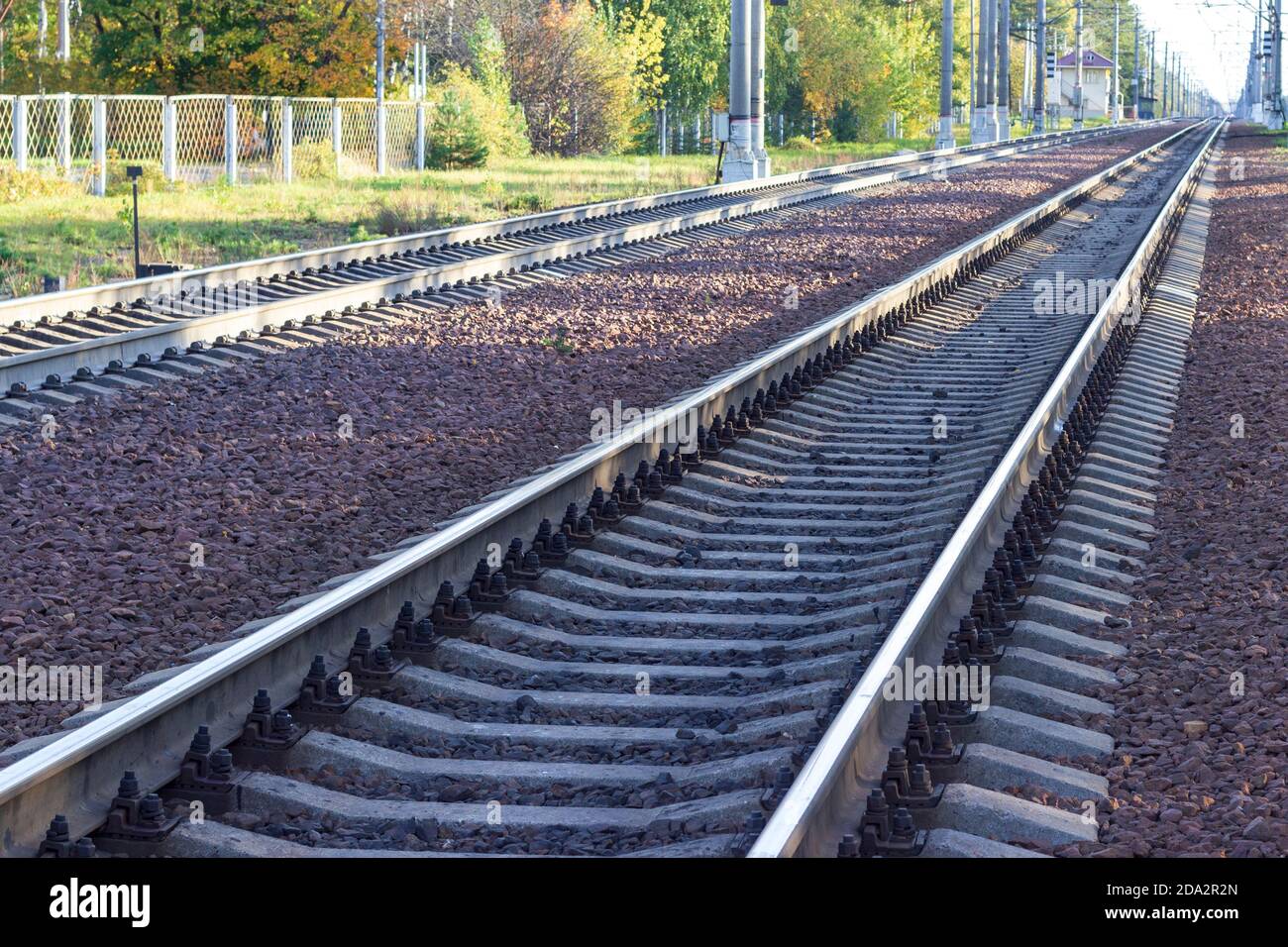 Railroad tracks with concrete sleepers stretching far beyond the ...