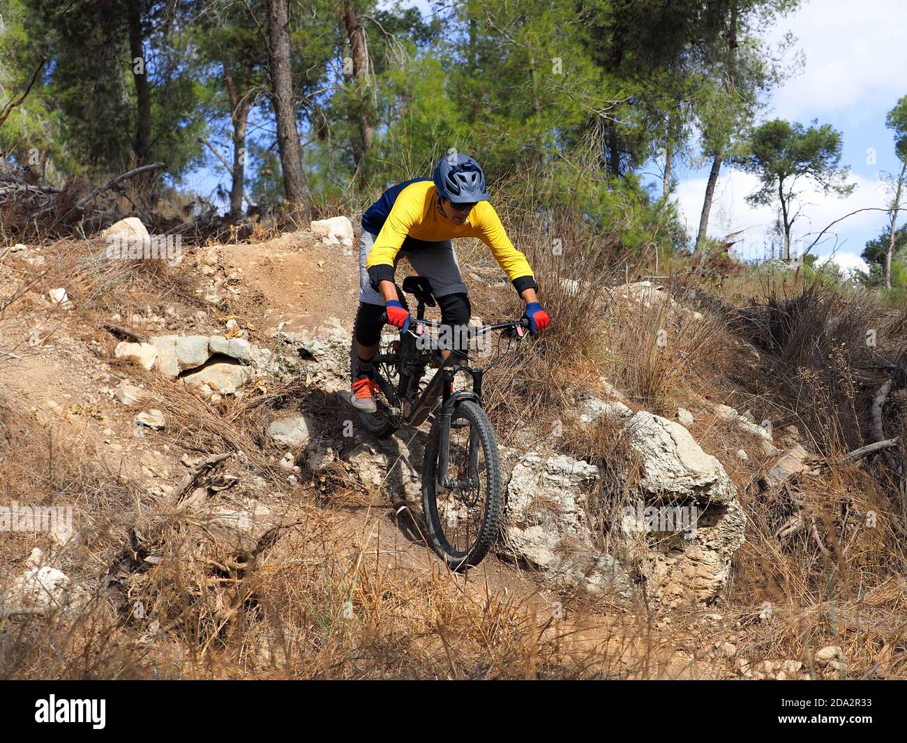 Mountain cyclist riding down a rocky slope. Mountain biking, Enduro ...