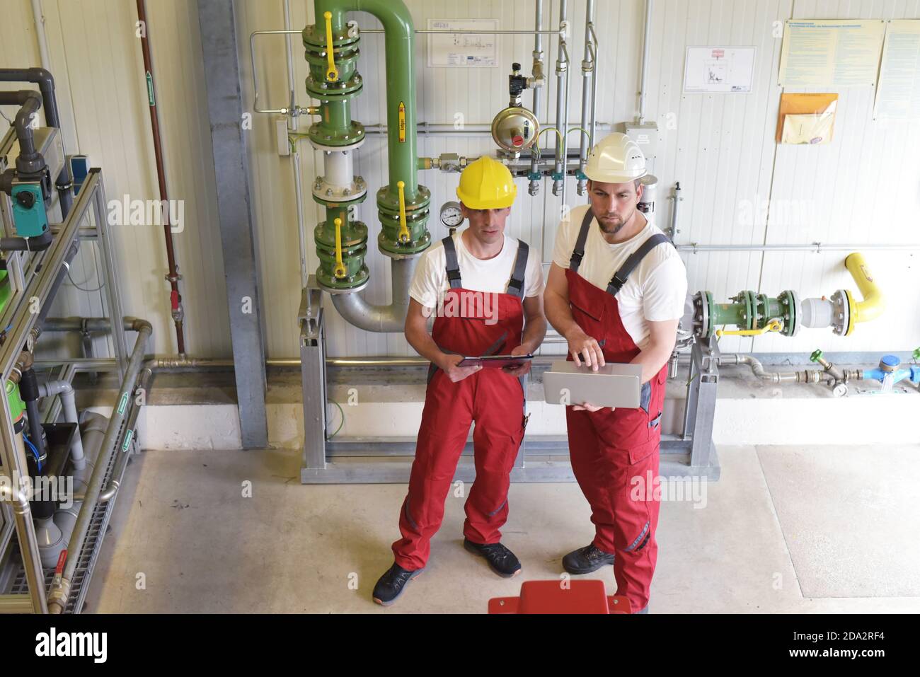 Mechanics repair a machine in a modern industrial plant - profession ...