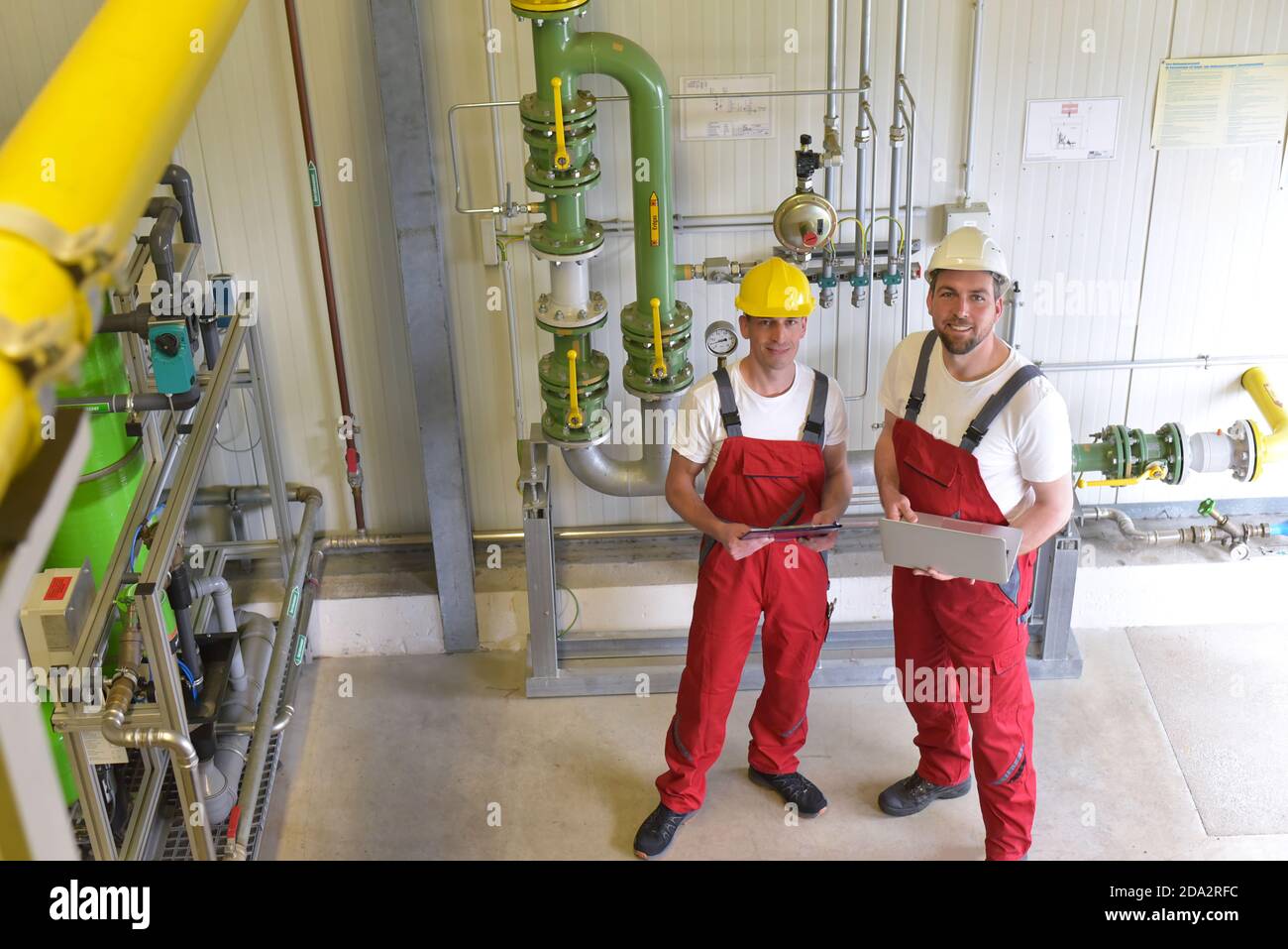 Mechanics repair a machine in a modern industrial plant - profession ...