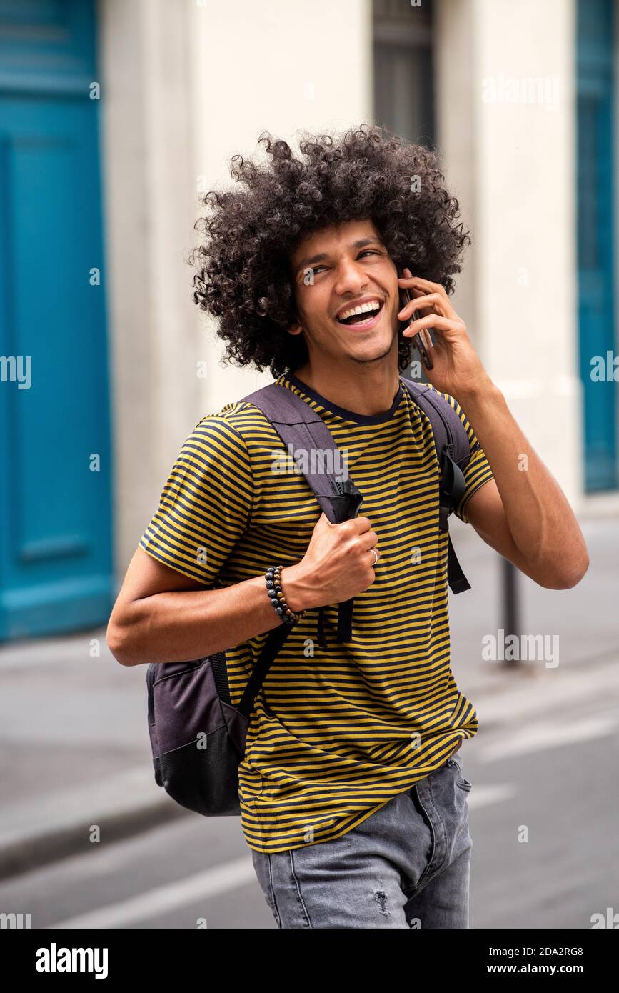Portrait happy young man talking with cellphone outdoors Stock Photo ...