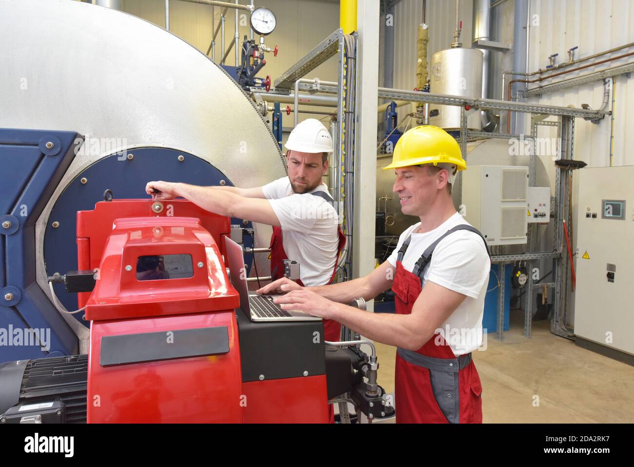 Mechanics repair a machine in a modern industrial plant - profession ...