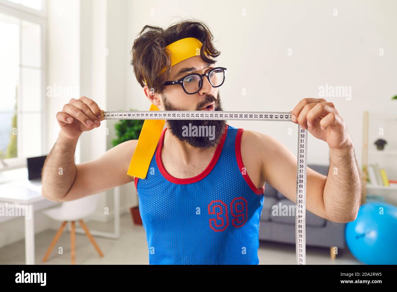 Goofy fitness geek demonstrating amazing weight loss result after ...