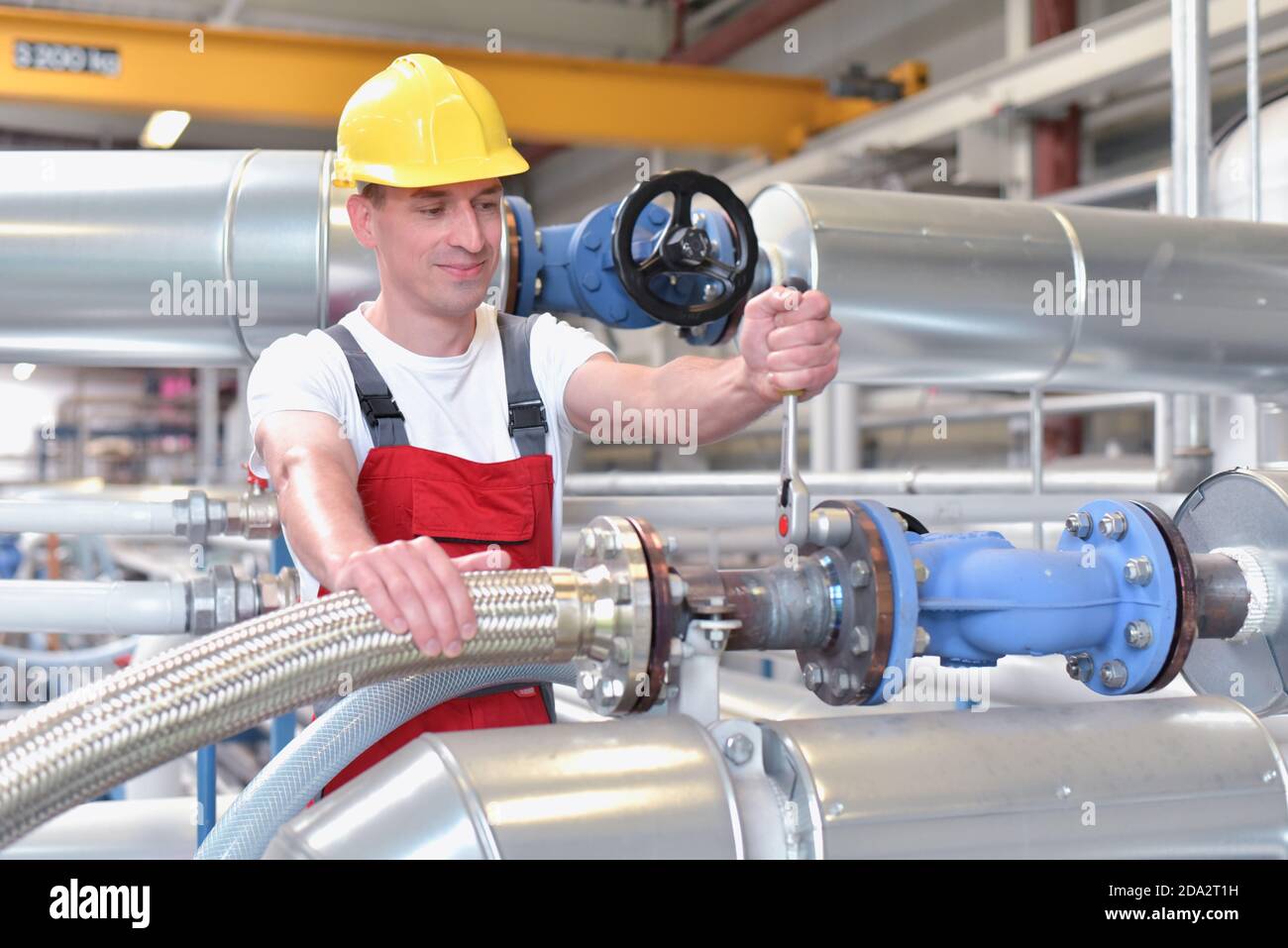 Mechanics repair a machine in a modern industrial plant - profession ...