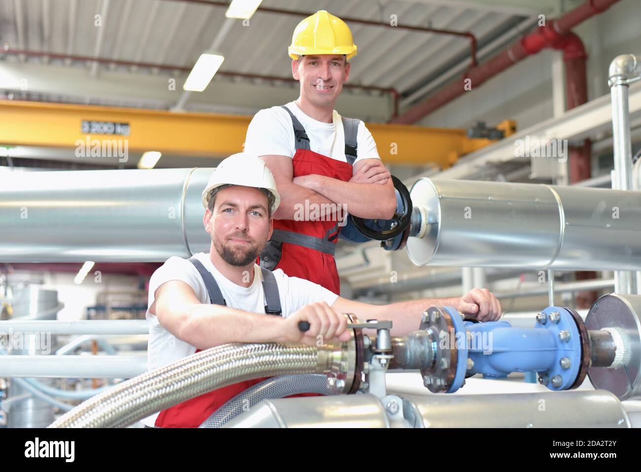 Mechanics repair a machine in a modern industrial plant - profession ...