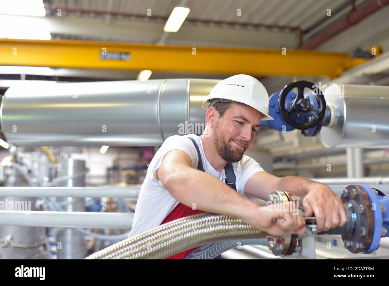 Mechanics repair a machine in a modern industrial plant - profession ...