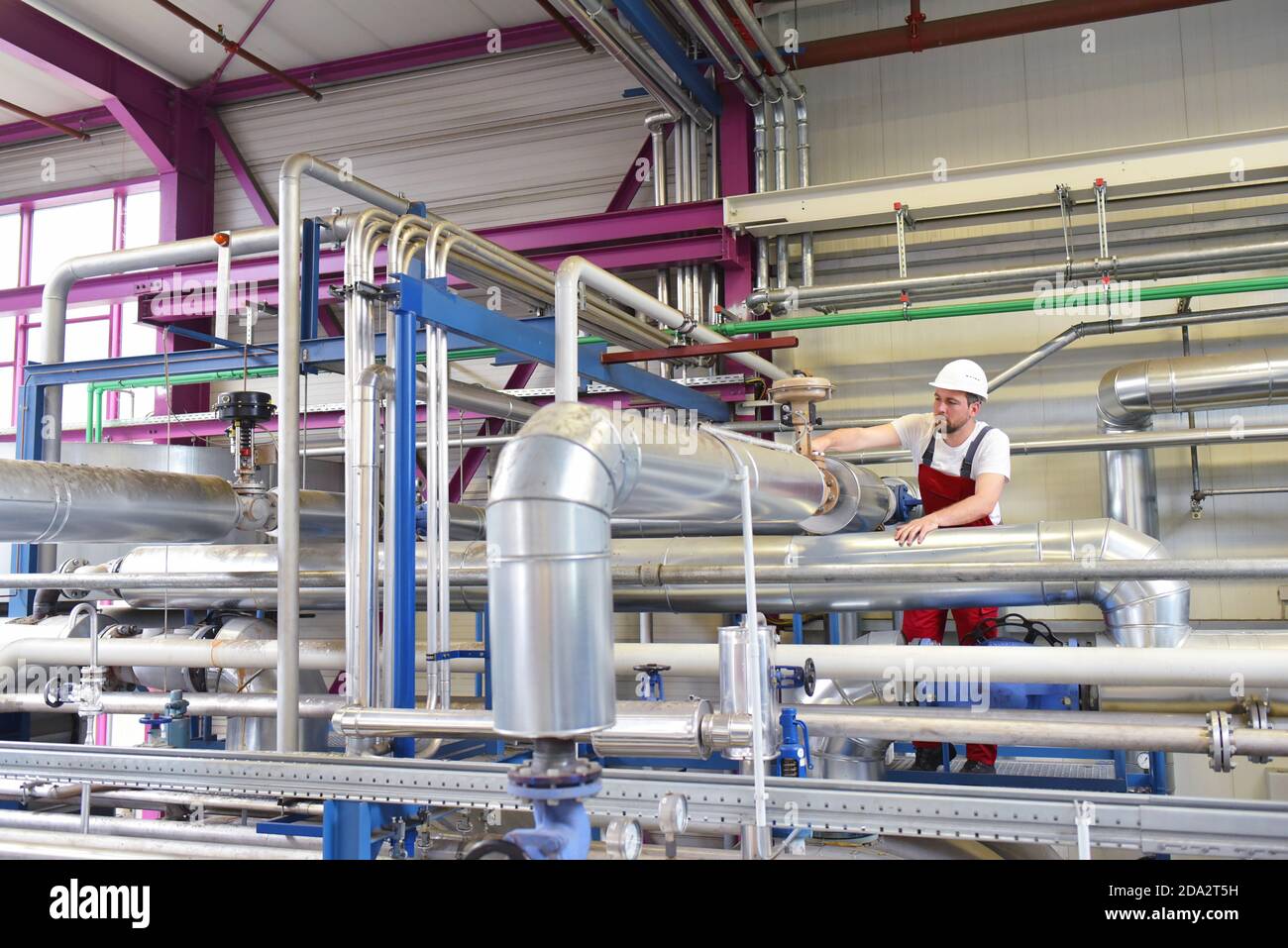 Mechanics repair a machine in a modern industrial plant - profession ...