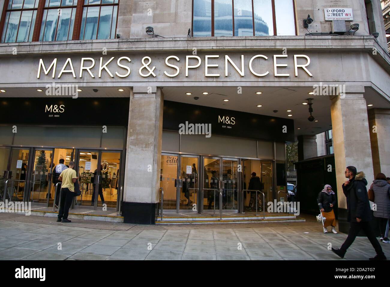 London, UK. 7th Nov, 2020. People walk past a branch of Marks and ...