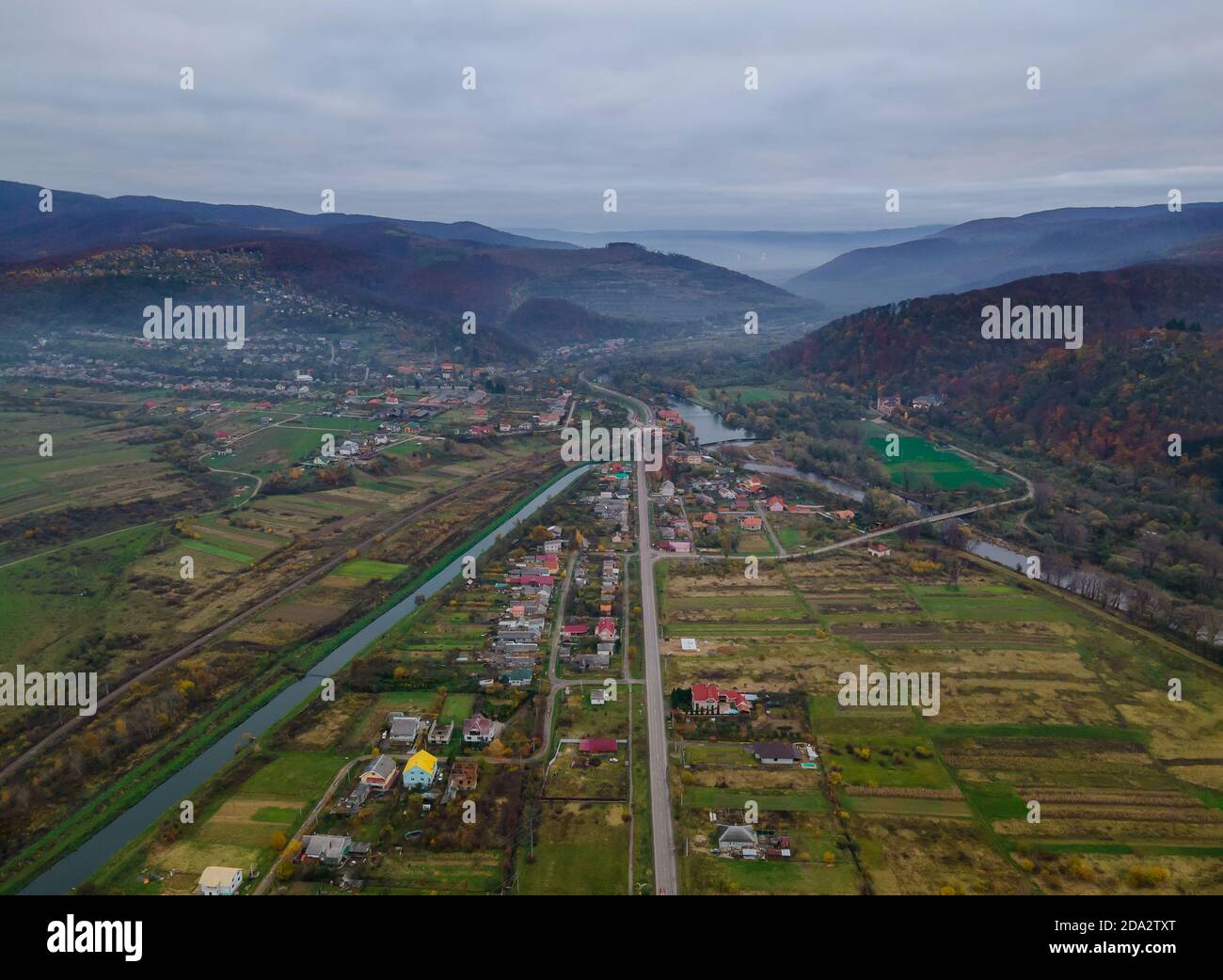 Aerial top dow view over suburb area village near mountain high ...