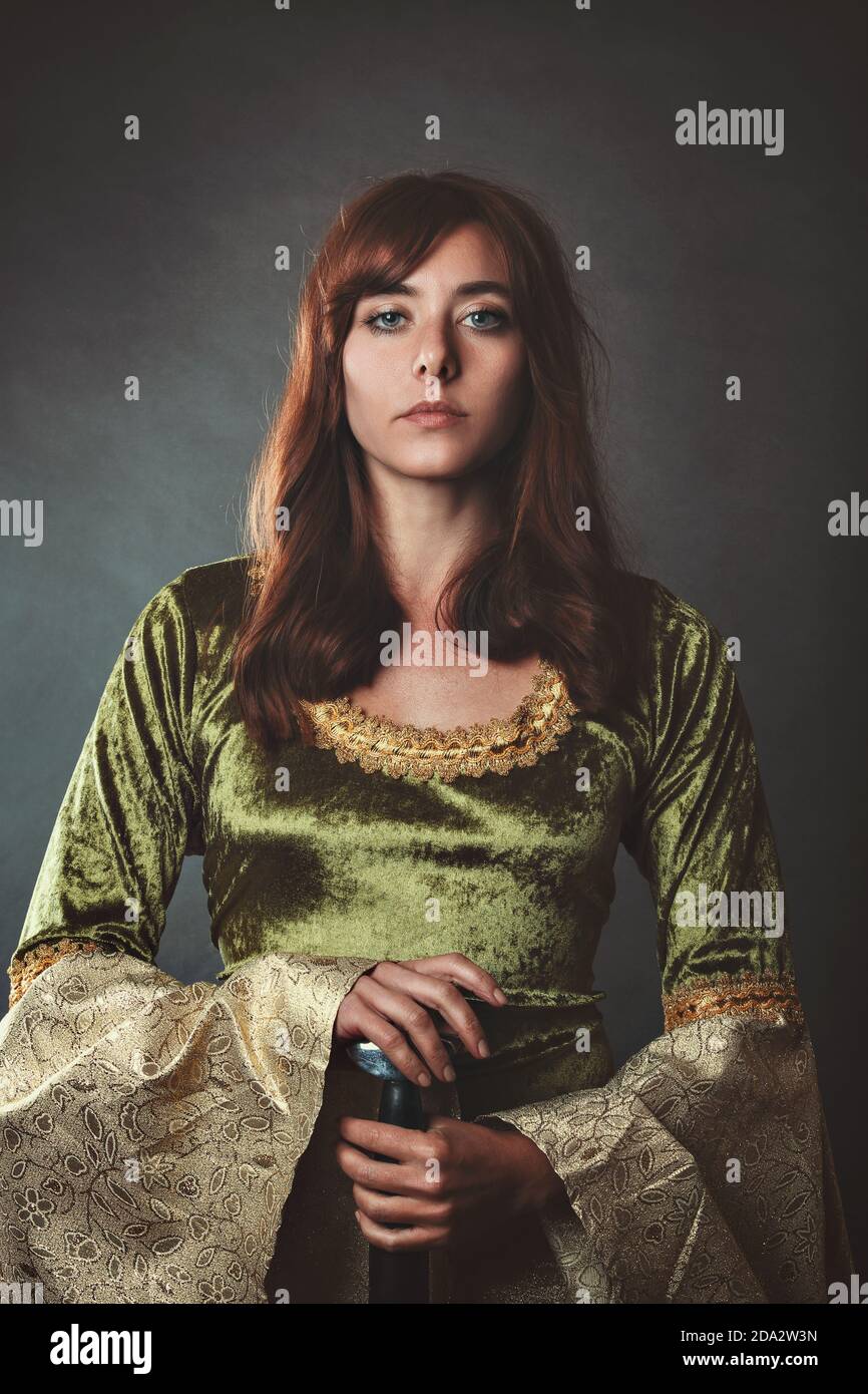 Beautiful medieval woman posing with sword Stock Photo - Alamy