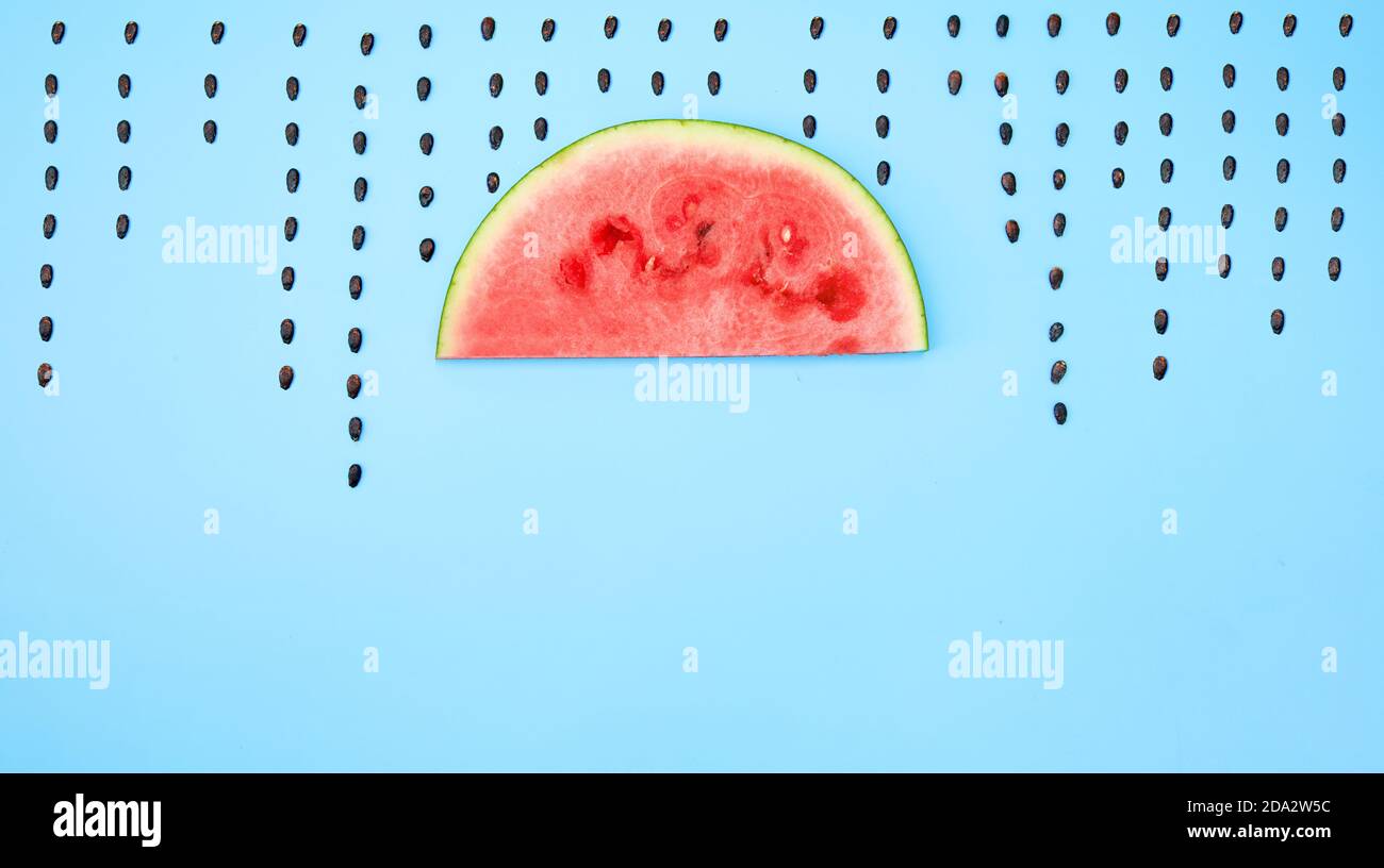 Top view of sliced watermelon with seeds raining isolated on a light ...