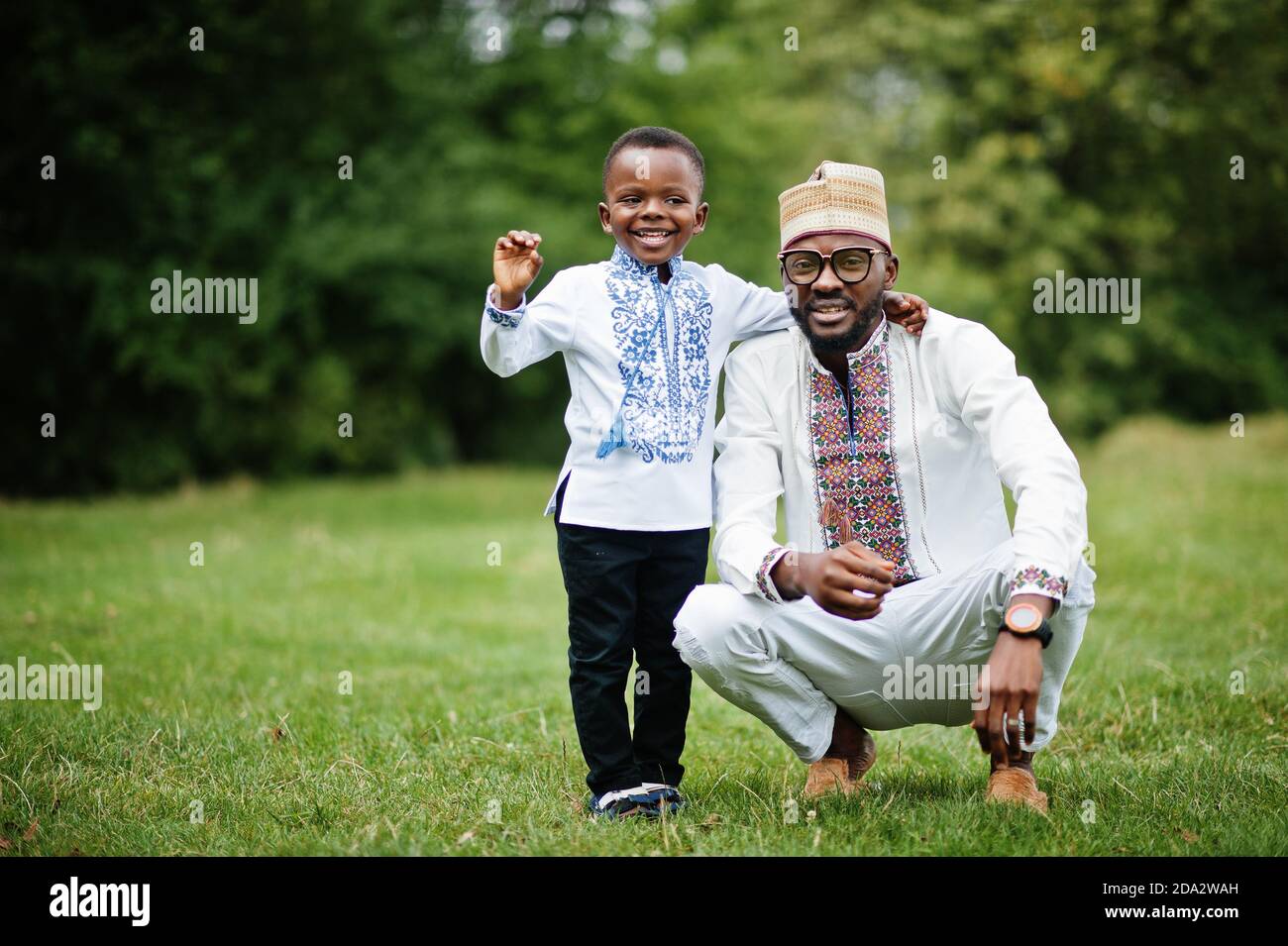 African father with son in traditional clothes at park Stock Photo - Alamy
