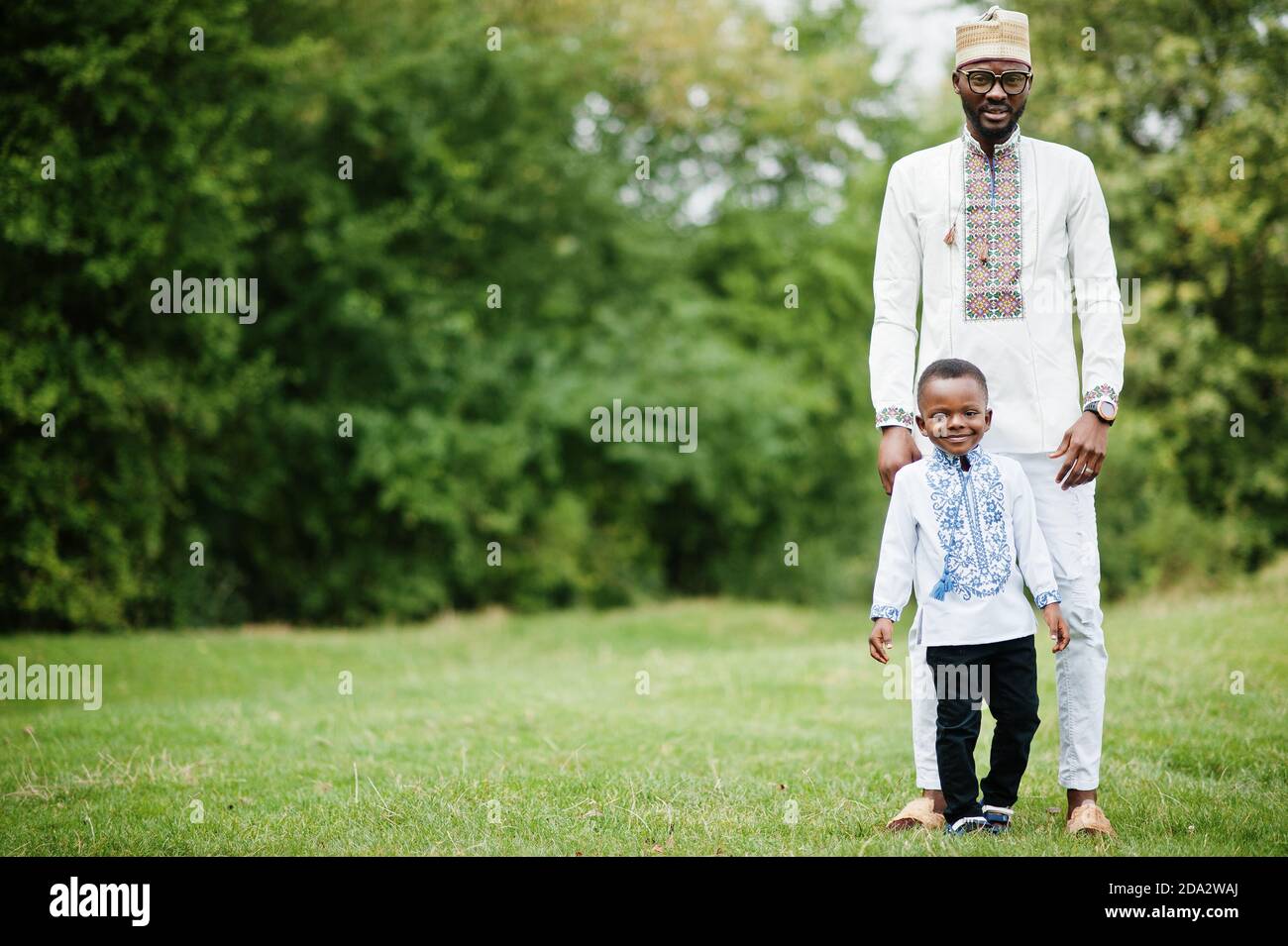 African father with son in traditional clothes at park Stock Photo - Alamy