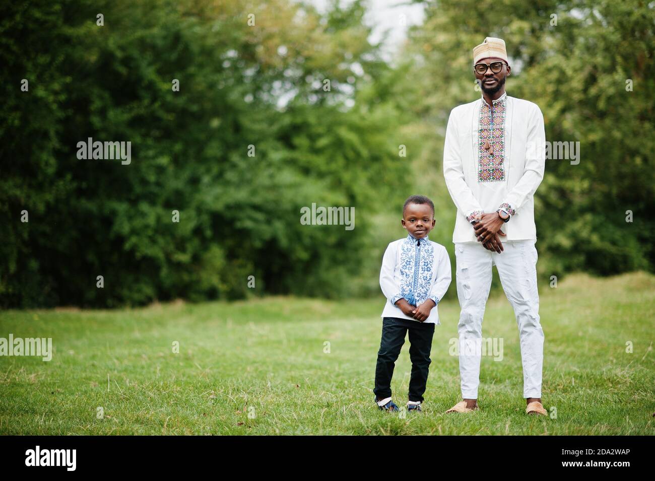 African father with son in traditional clothes at park Stock Photo - Alamy