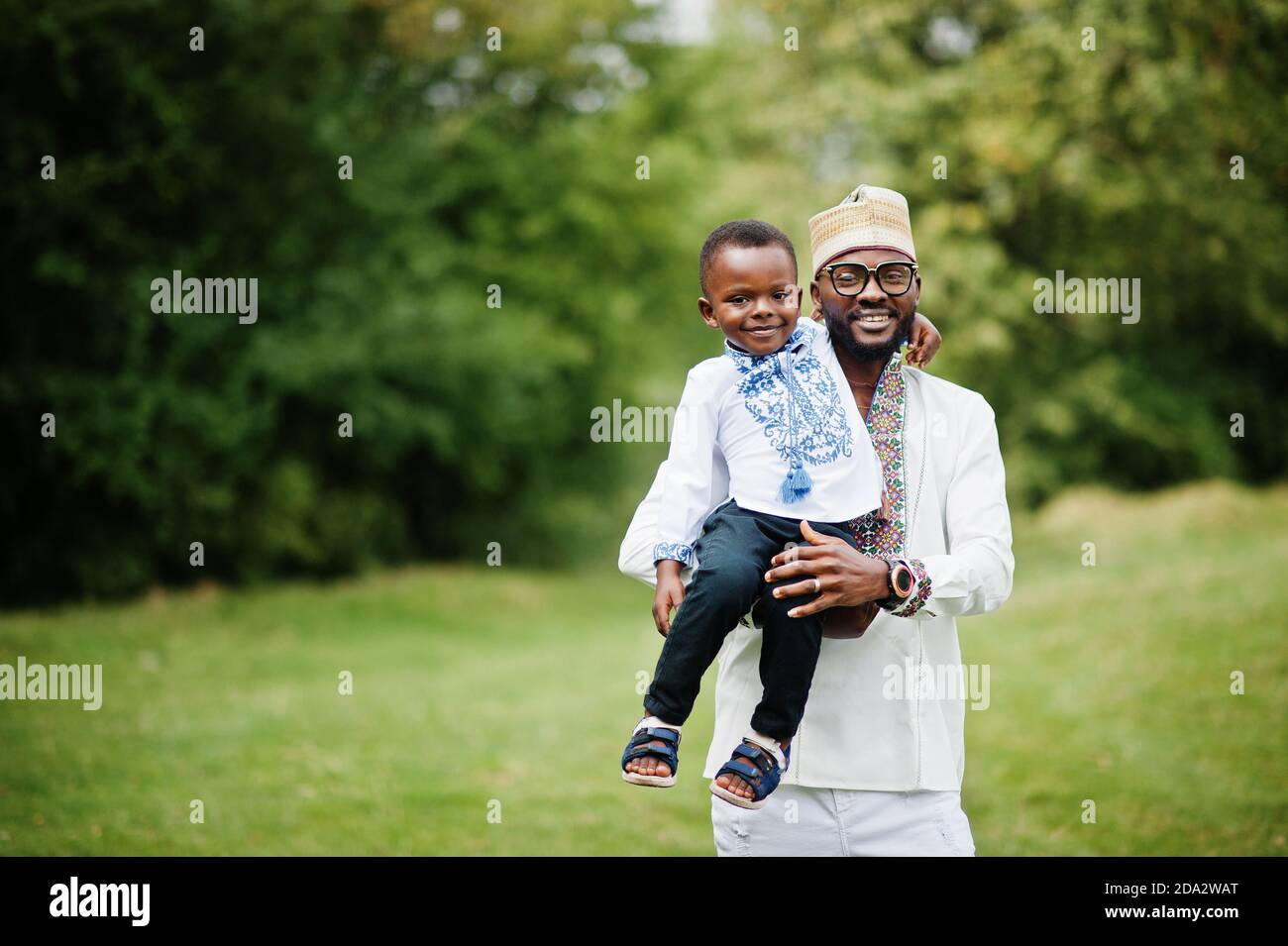 African father with son in traditional clothes at park Stock Photo - Alamy
