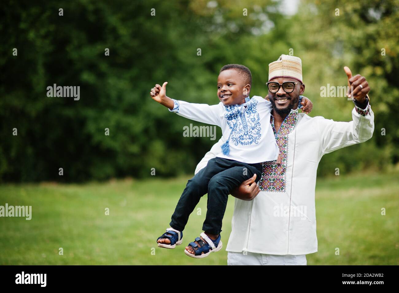 African father with son in traditional clothes at park Stock Photo - Alamy