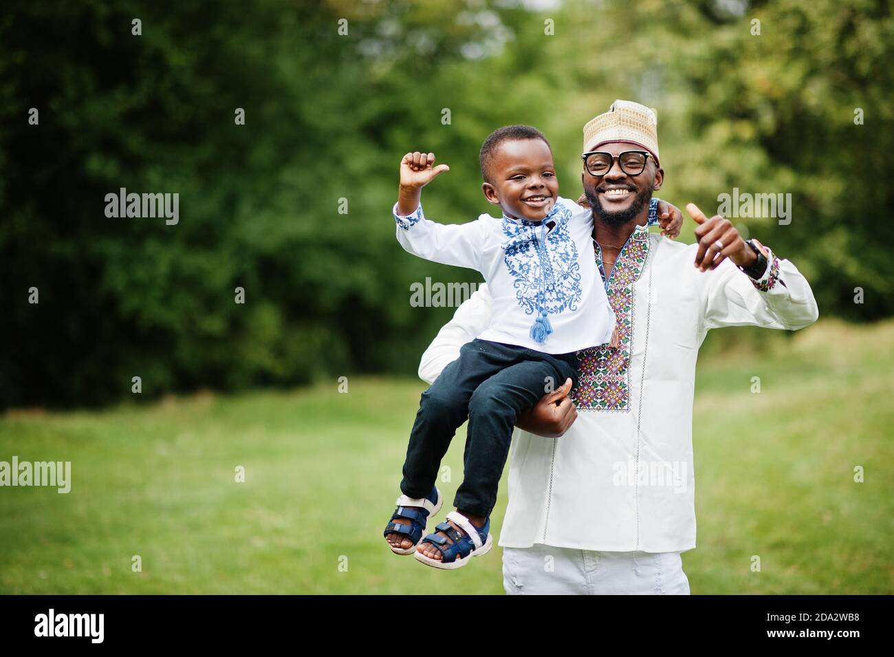 African father with son in traditional clothes at park Stock Photo - Alamy