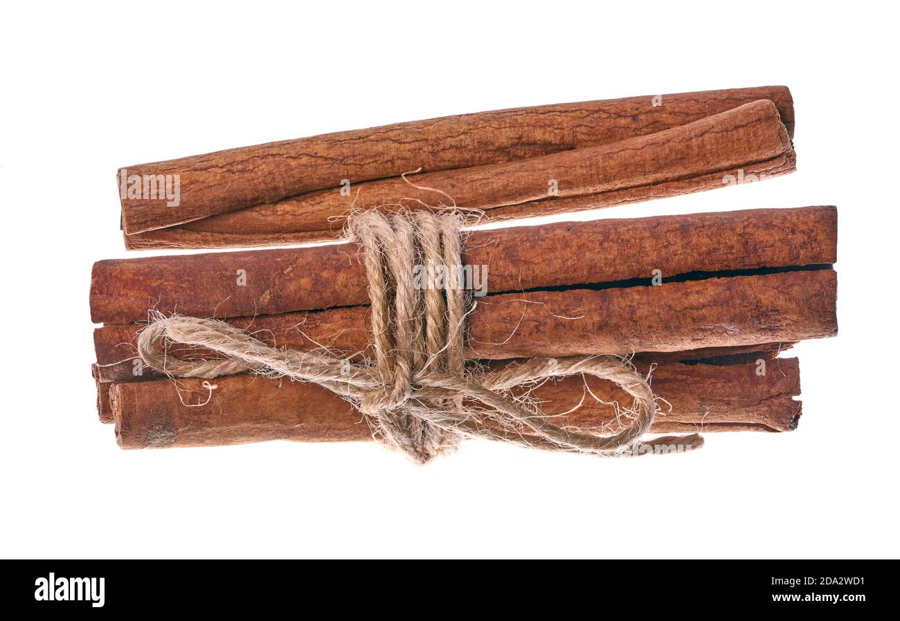 Cinnamon dried sticks with rope on white background Stock Photo - Alamy