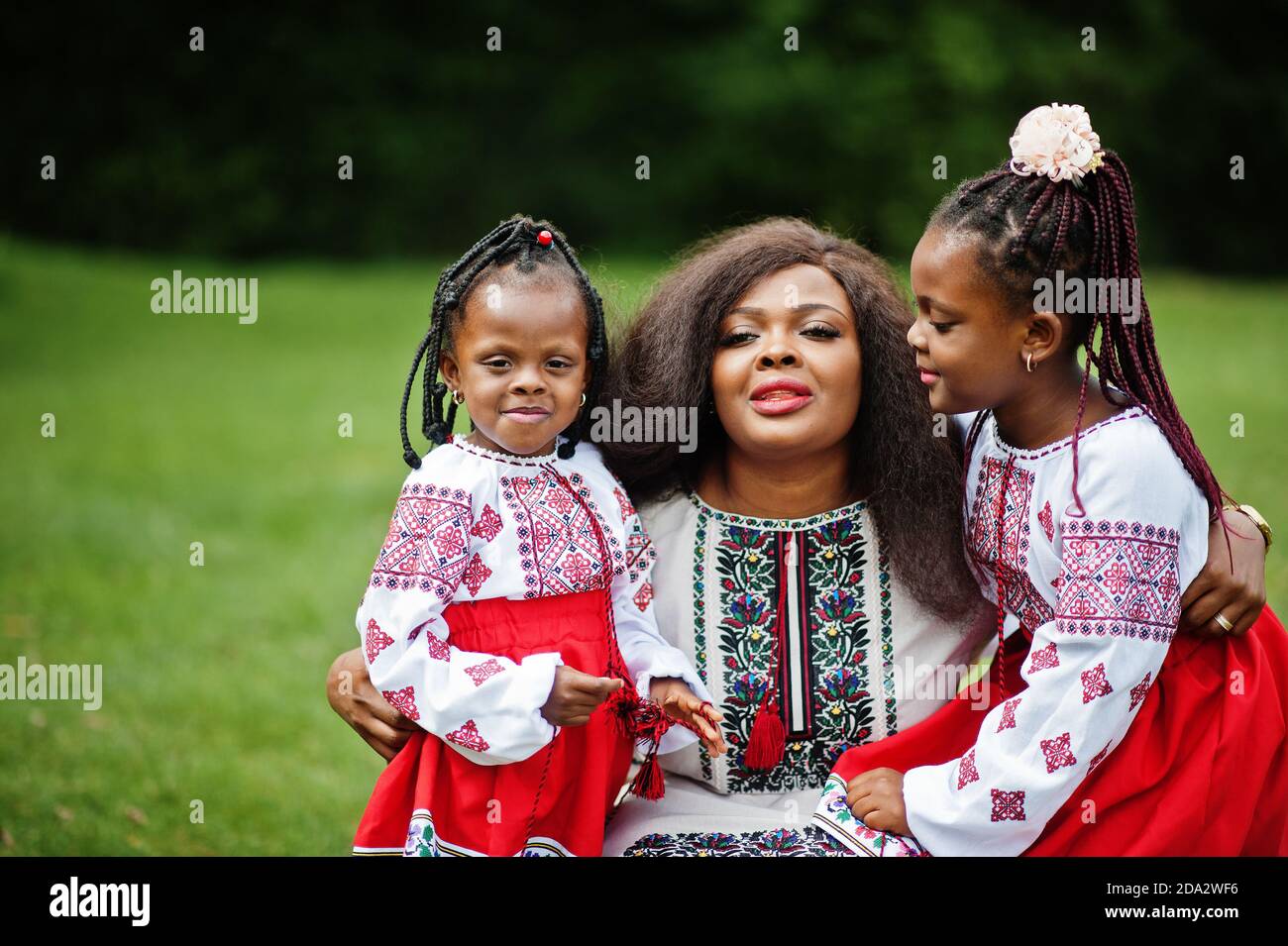 African mother with daugters in traditional clothes at park Stock Photo ...