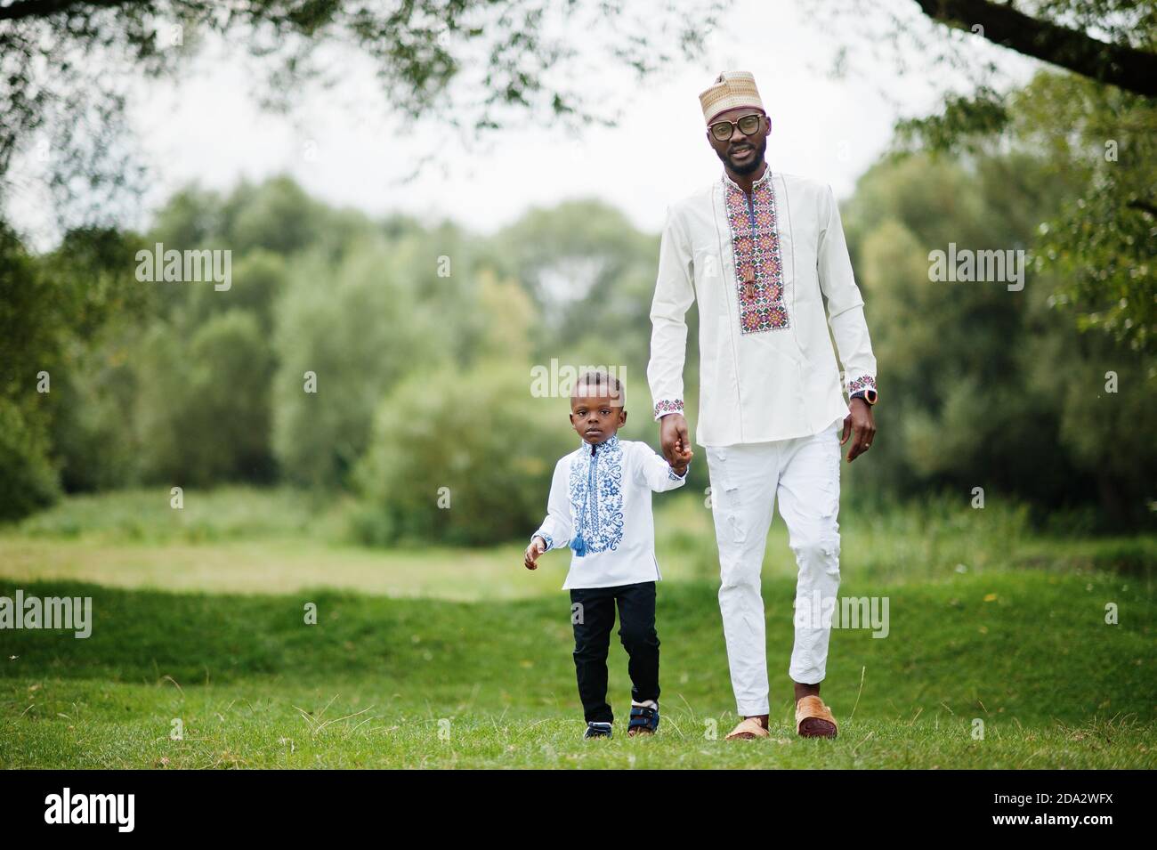 African father with son in traditional clothes at park Stock Photo - Alamy