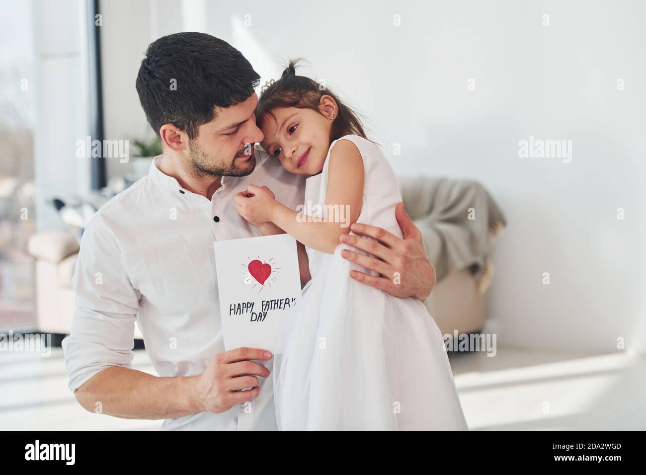 Happy father's day. Daughter makes surprise for dad by giving postcard ...