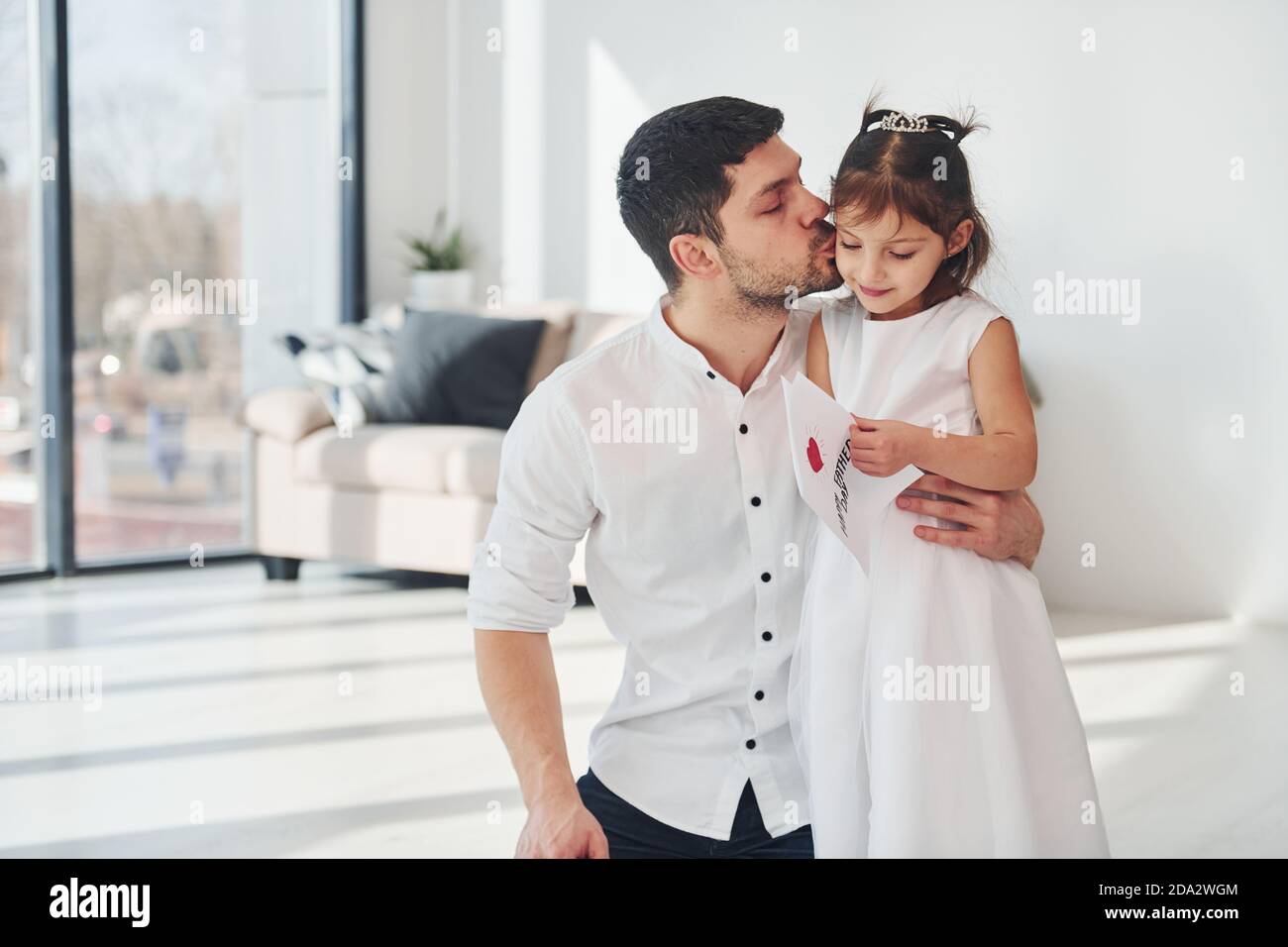 Happy father's day. Daughter makes surprise for dad by giving postcard ...