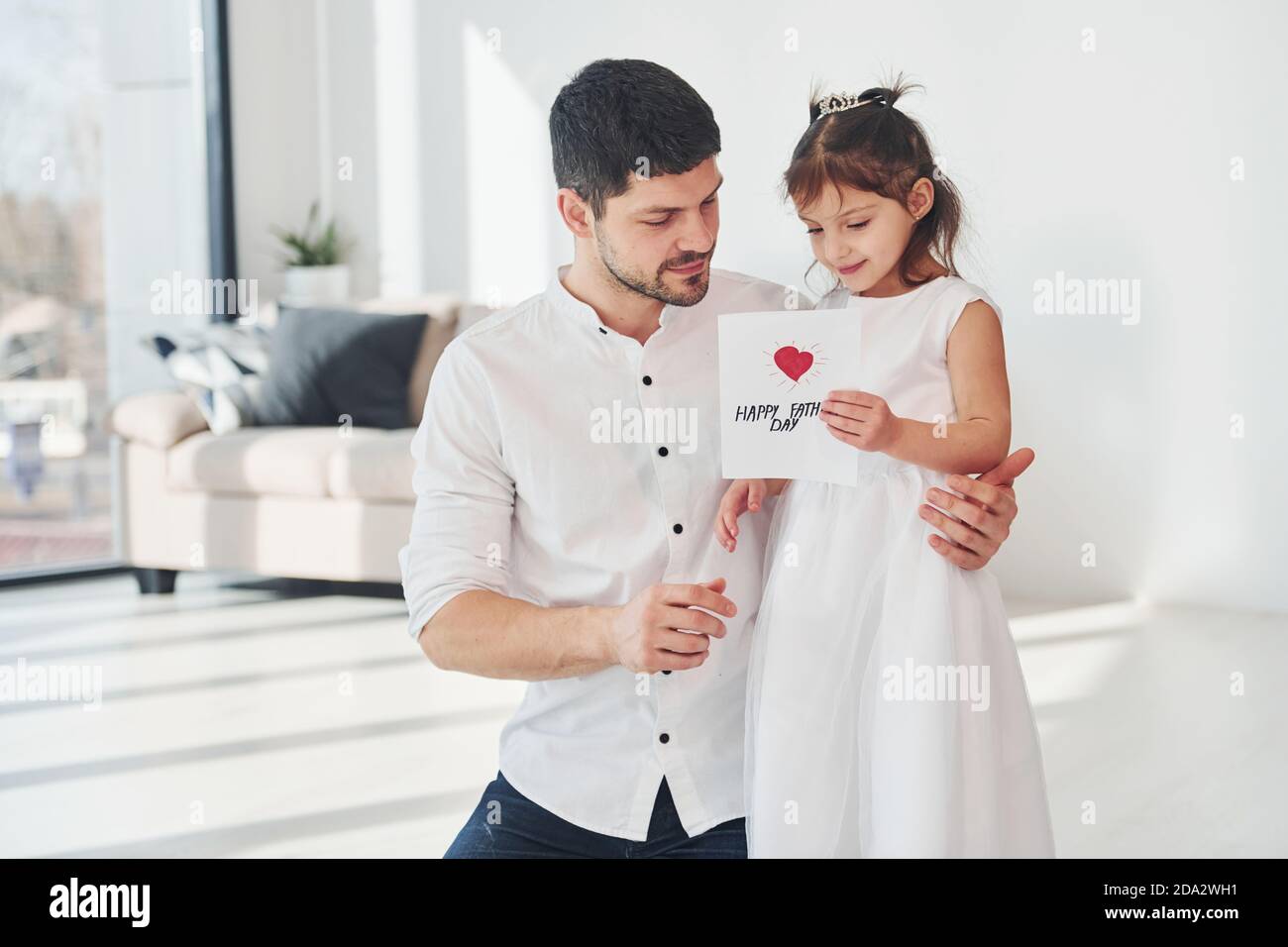 Happy father's day. Daughter makes surprise for dad by giving postcard ...