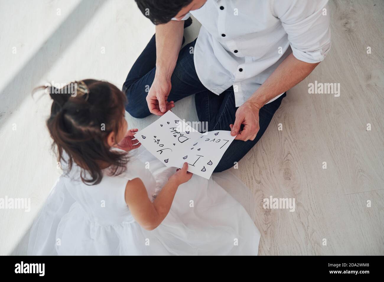 Happy father's day. Daughter makes surprise for dad by giving postcard ...