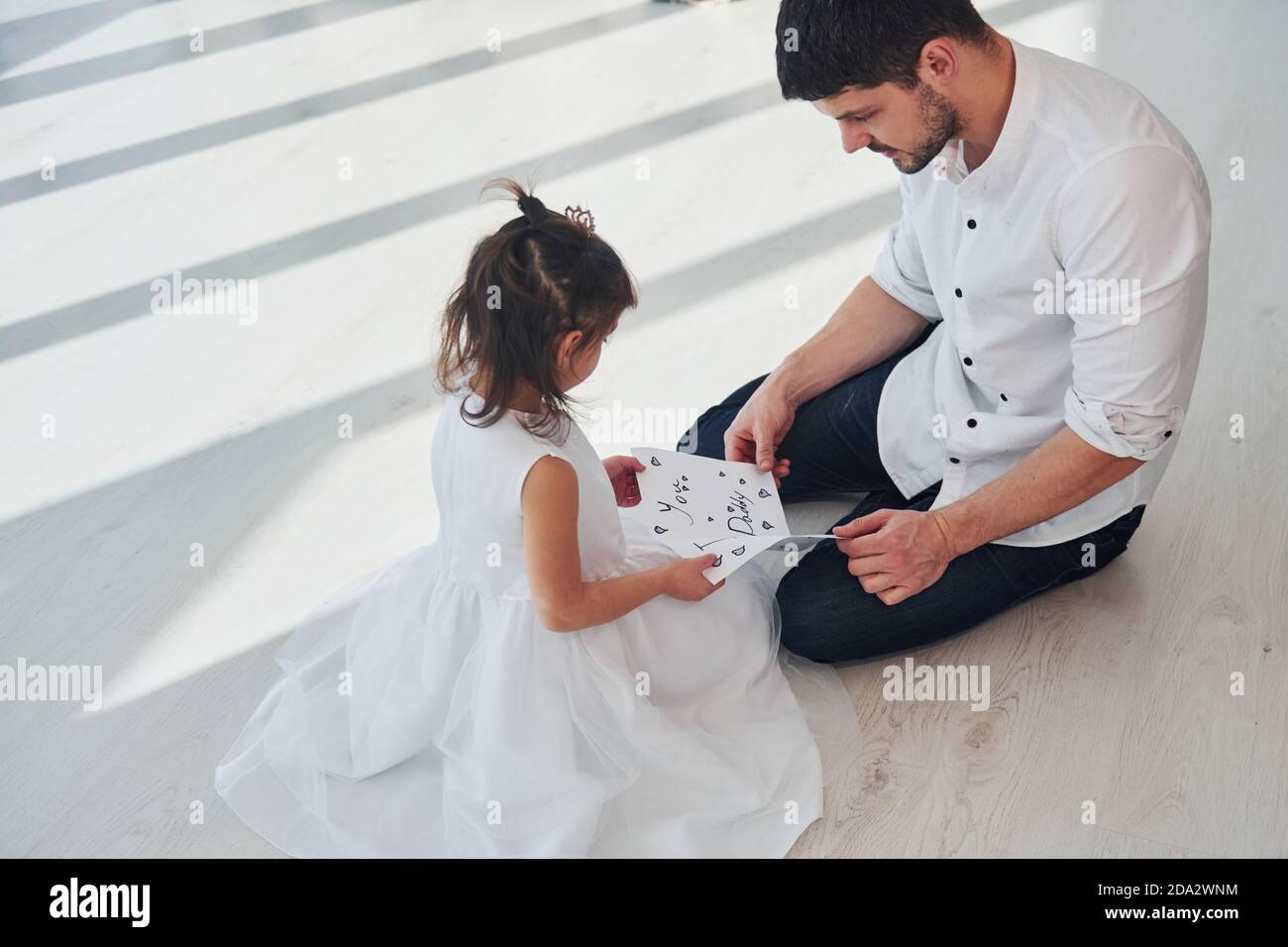 Happy father's day. Daughter makes surprise for dad by giving postcard ...