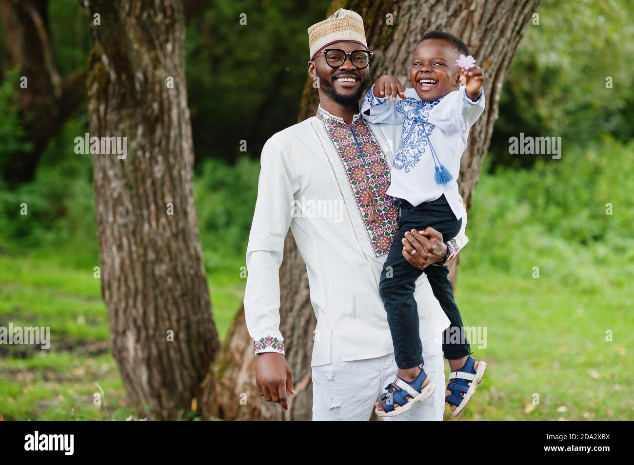 African father with son in traditional clothes at park Stock Photo - Alamy