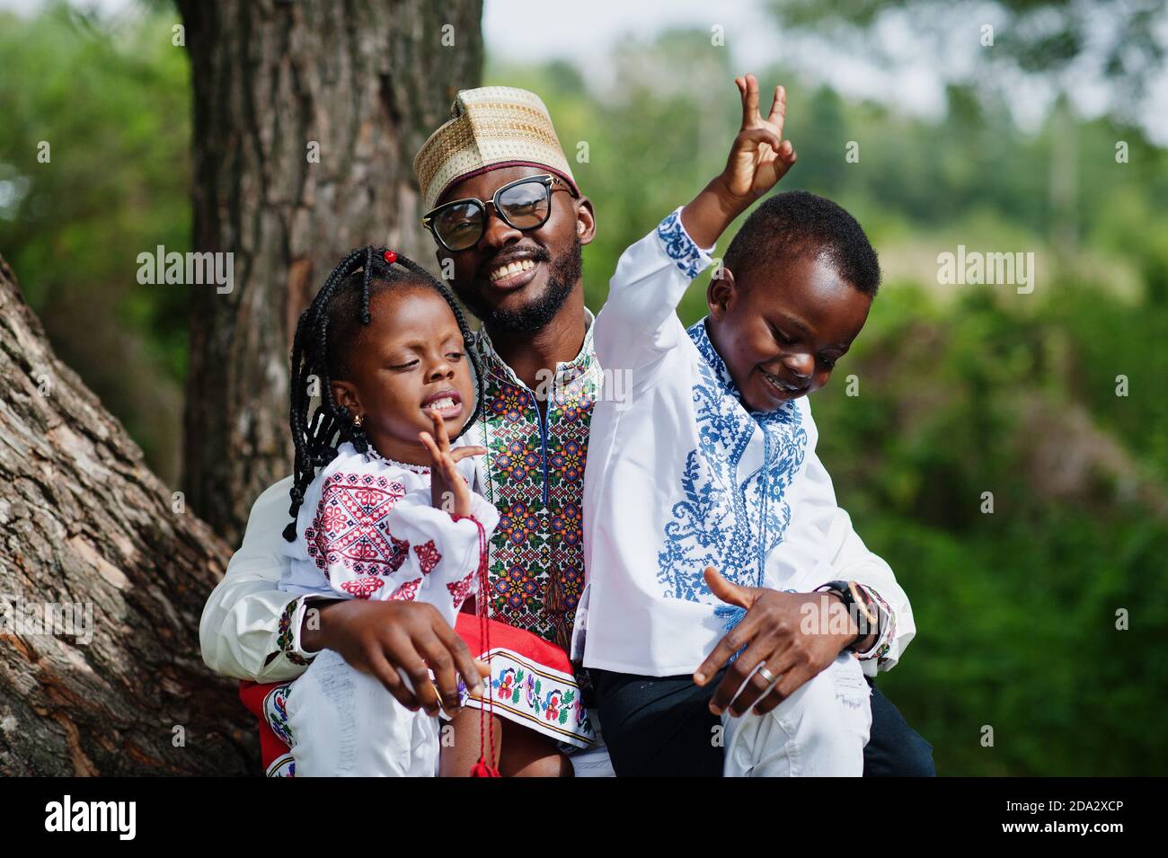African father with kids in traditional clothes at park Stock Photo - Alamy