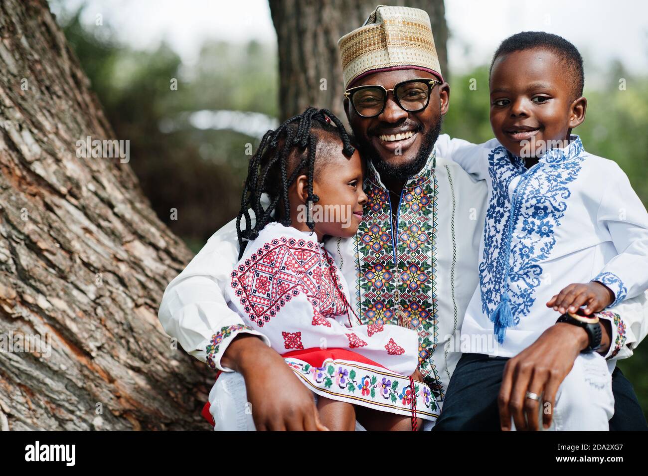 African father with kids in traditional clothes at park Stock Photo - Alamy