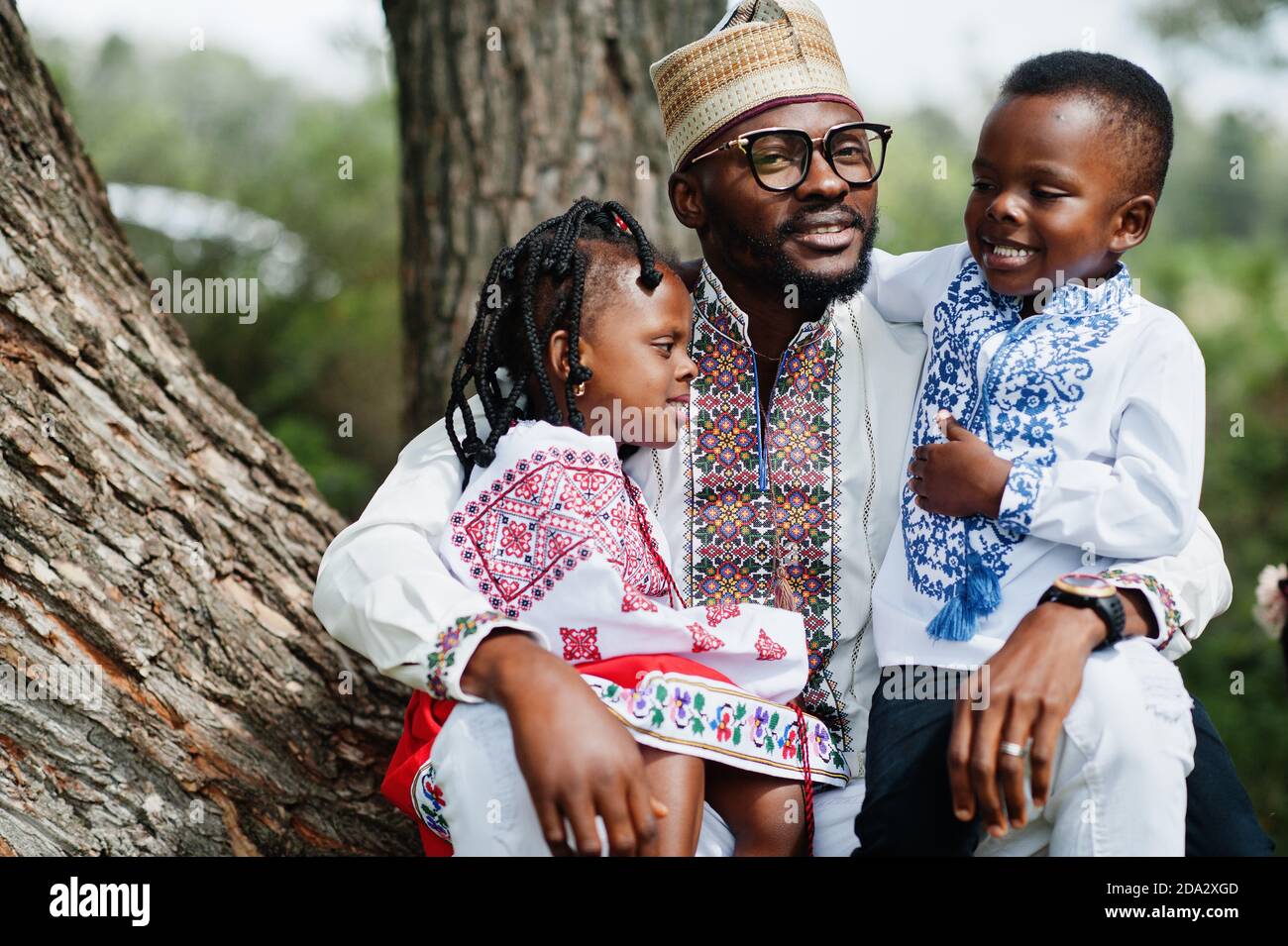 African father with kids in traditional clothes at park Stock Photo - Alamy
