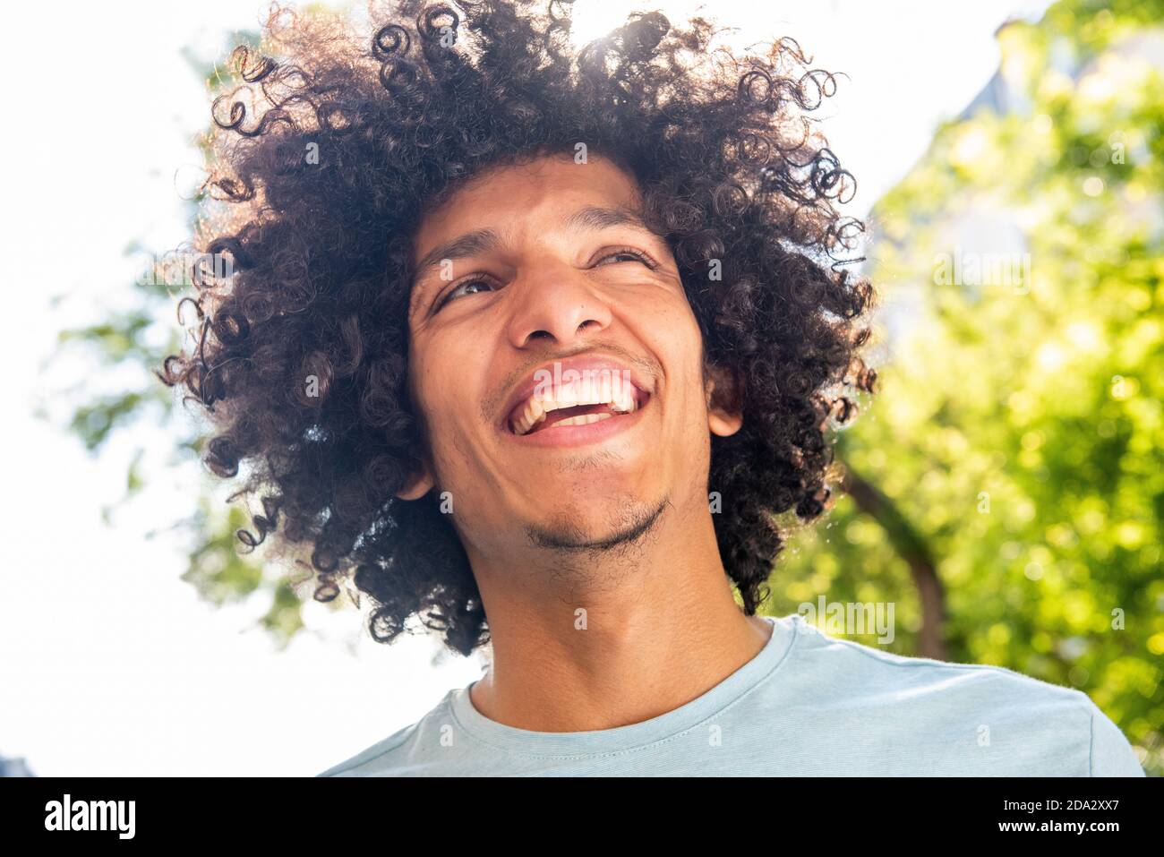 Close up portrait happy young arabic man with afro hair outdoors Stock ...