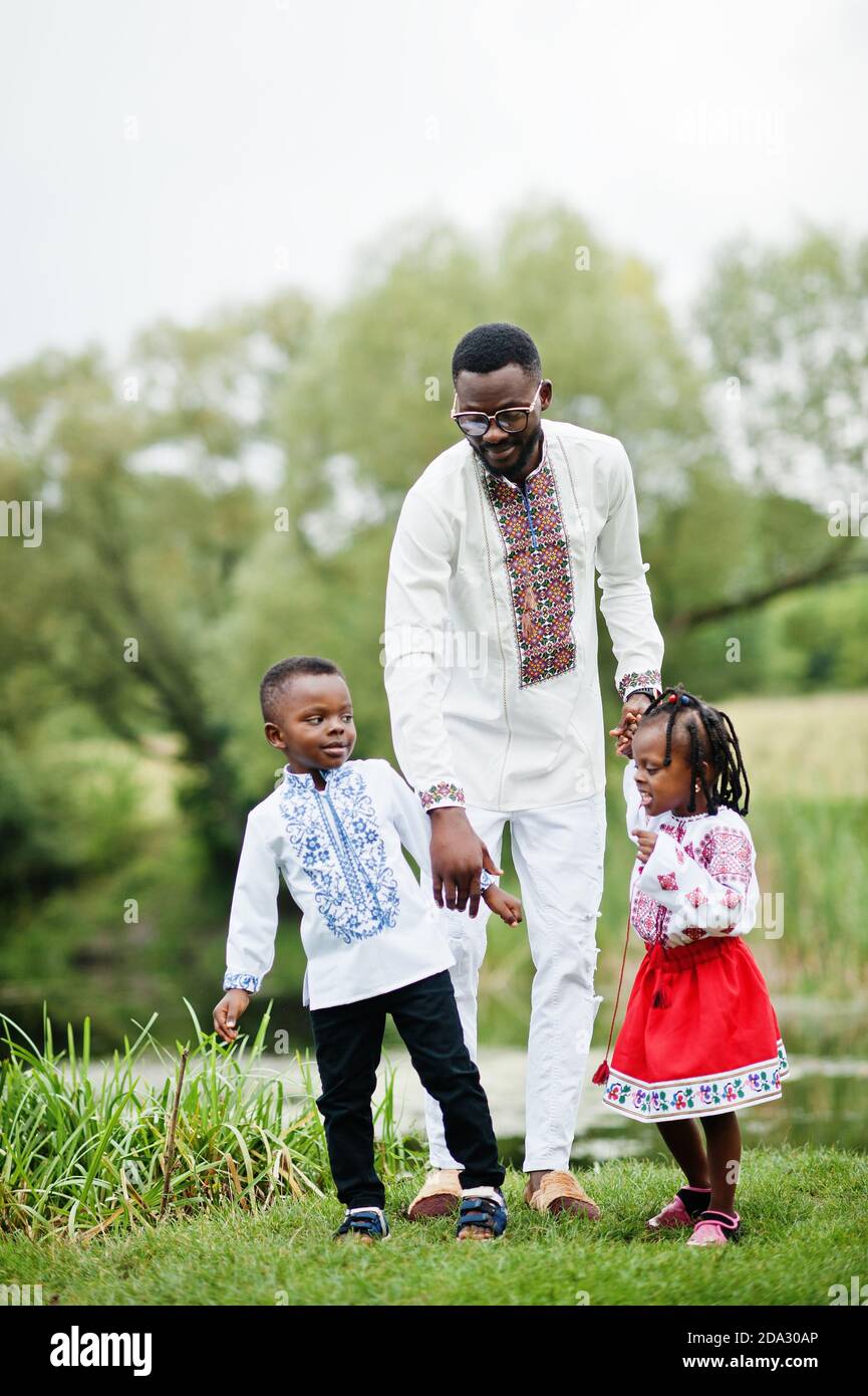 African father with kids in traditional clothes at park Stock Photo - Alamy