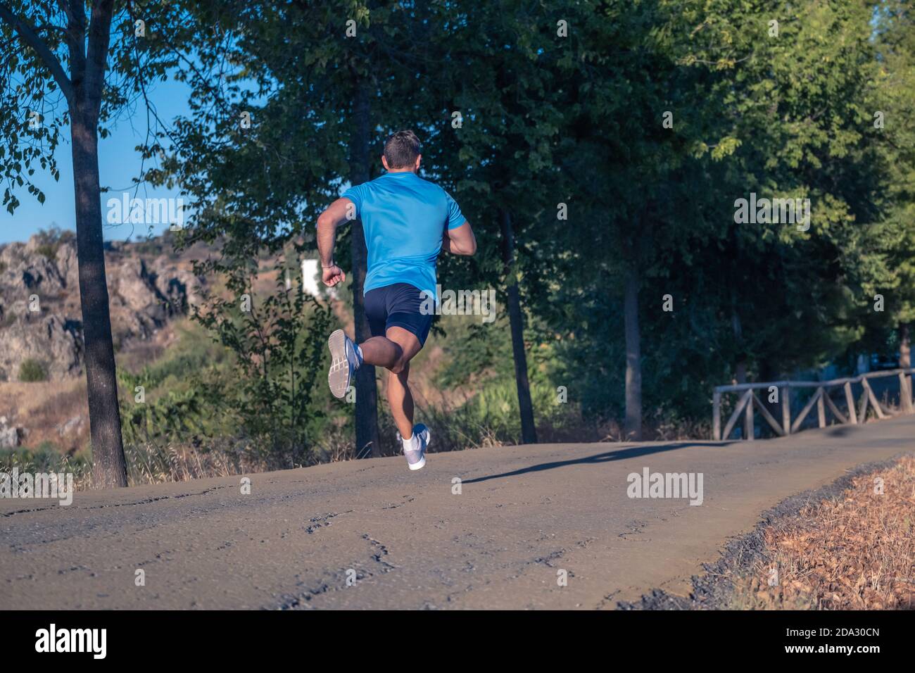 Man jogging through a park hi-res stock photography and images - Alamy