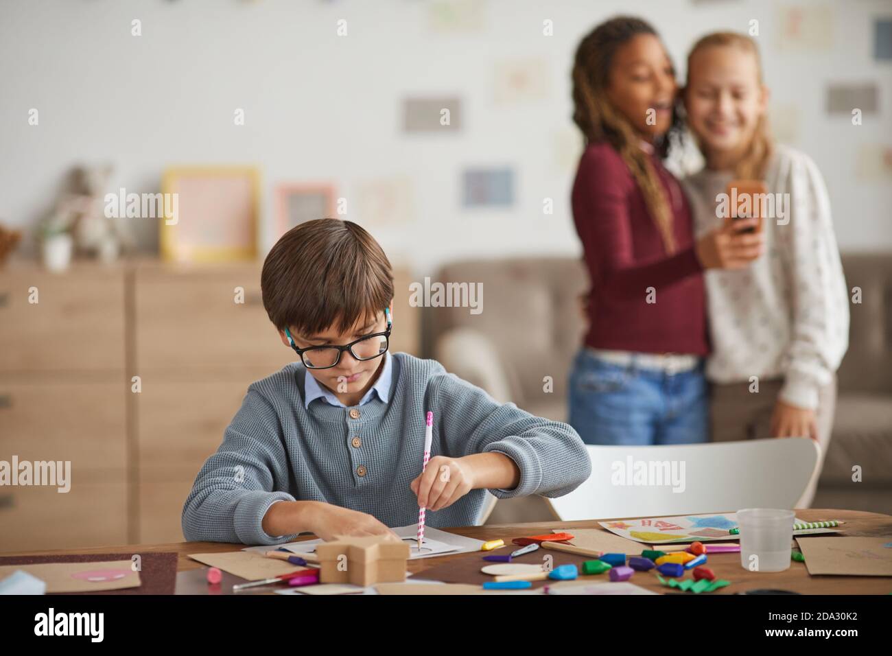 Portrait of smart little boy tracing shapes while drawing n art and ...