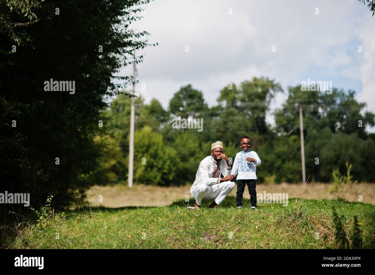 African father with son in traditional clothes at park Stock Photo - Alamy