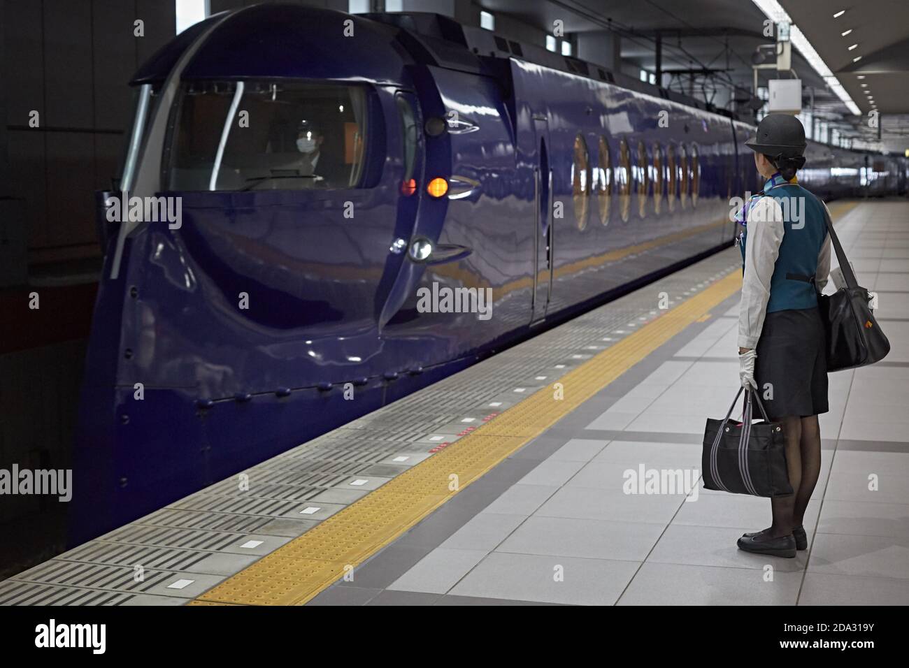 Osaka, Japan, April 2018. Stewardess waiting the Rapi:t, the Nankai 50000 series, the retro ...