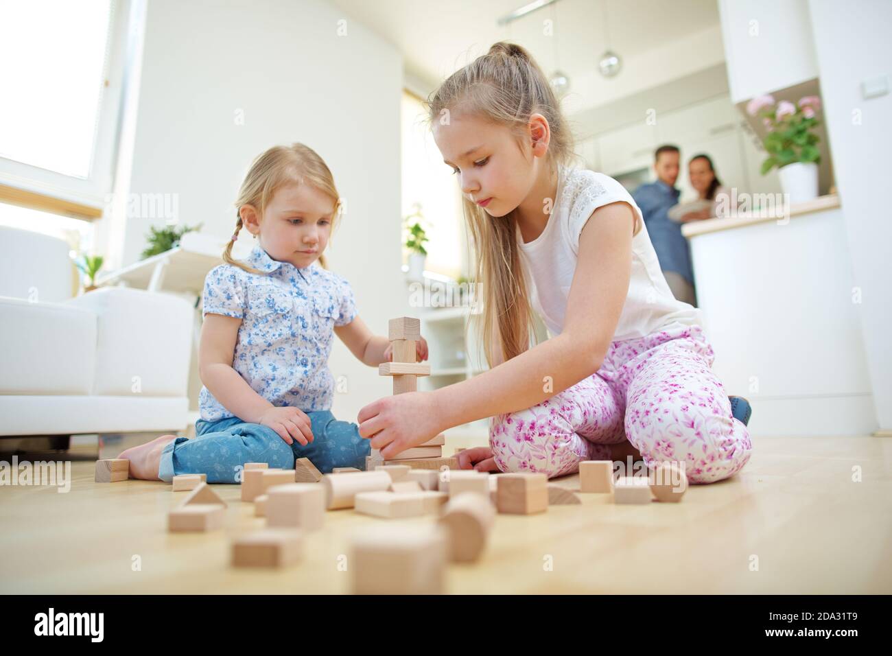 Young family building blocks hi-res stock photography and images - Alamy